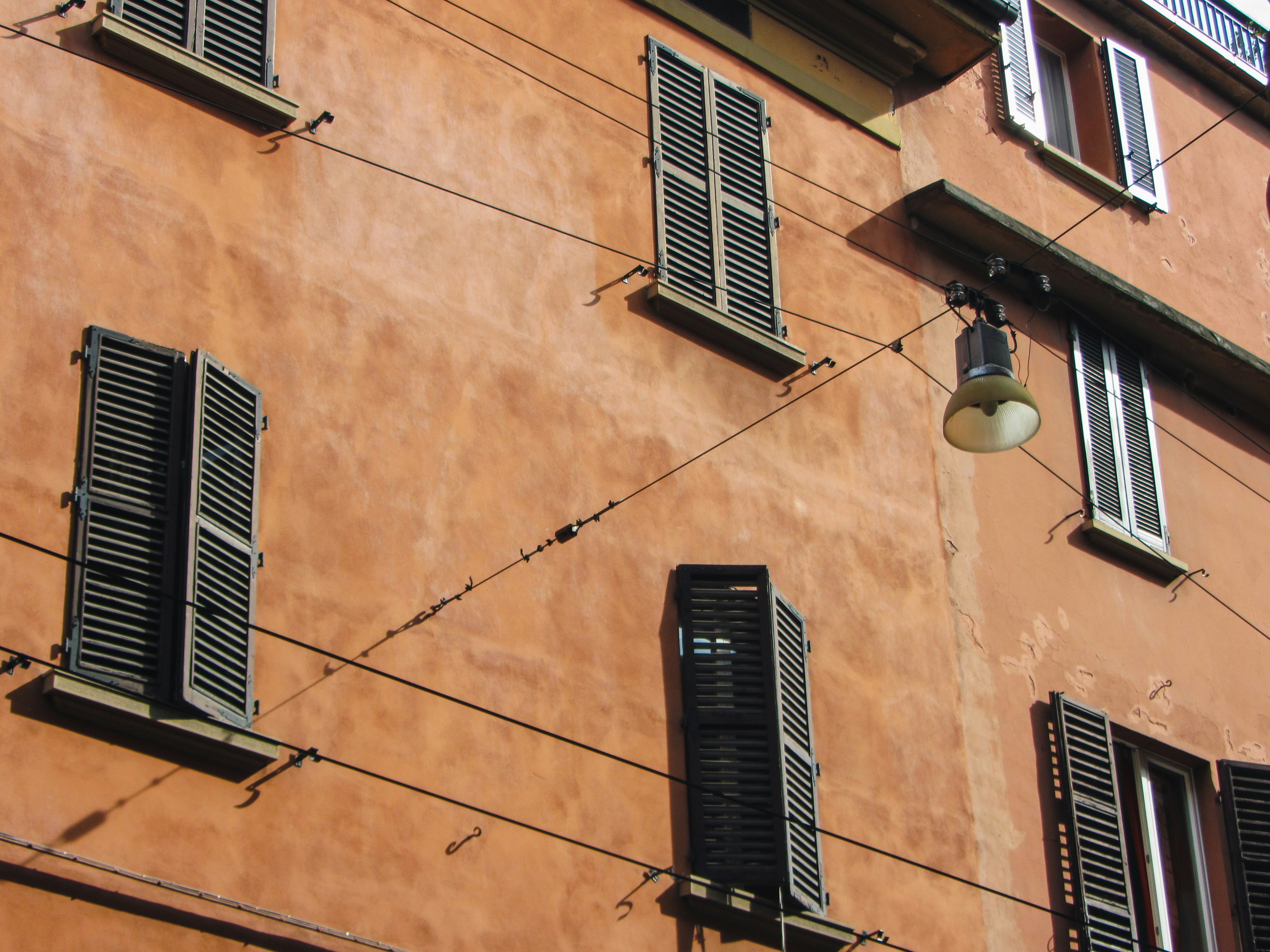 The view looking up from a street in Bologna, Italy