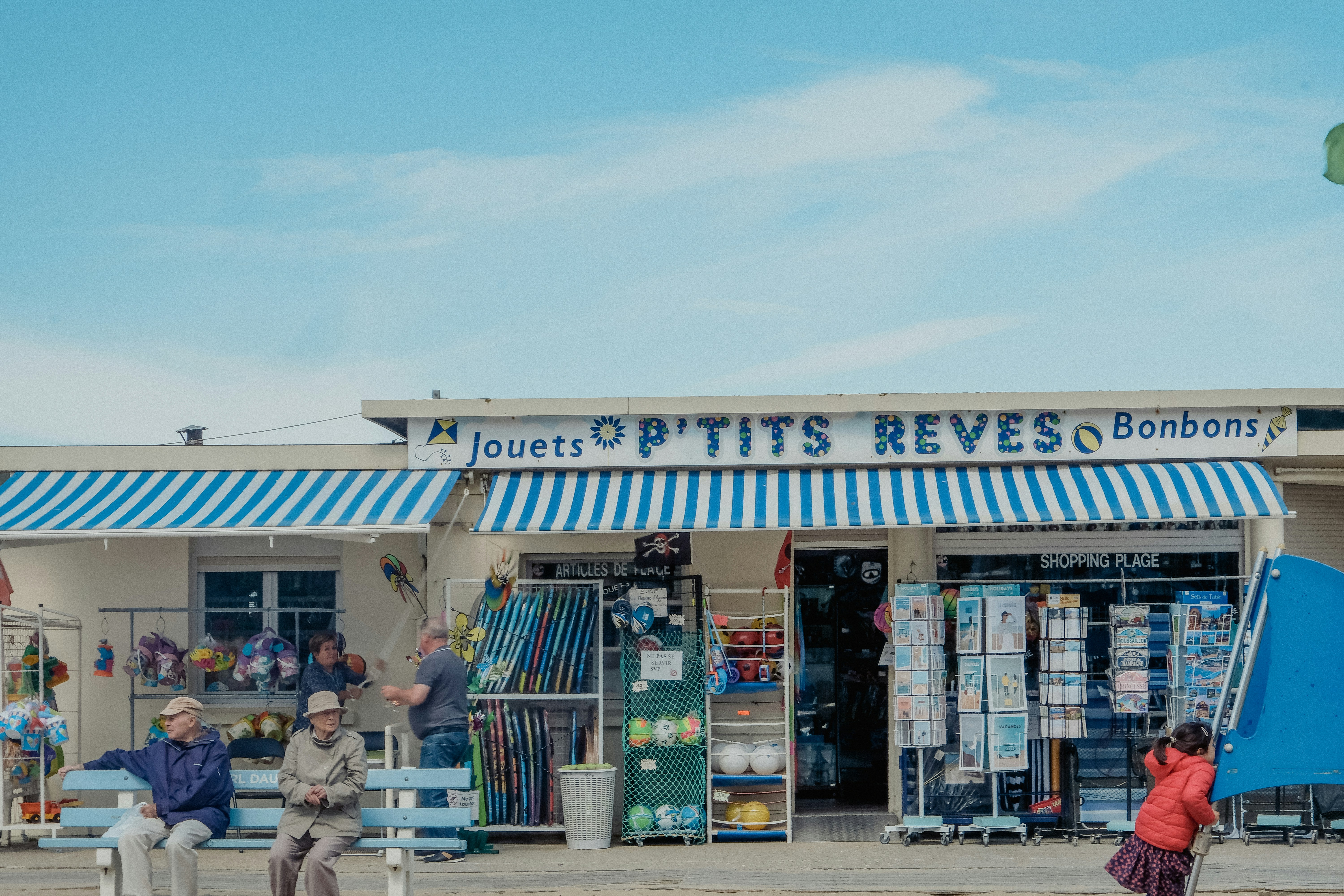 Striped Awnings and Seaside Toys: A Quiet Pierfront Snapshot