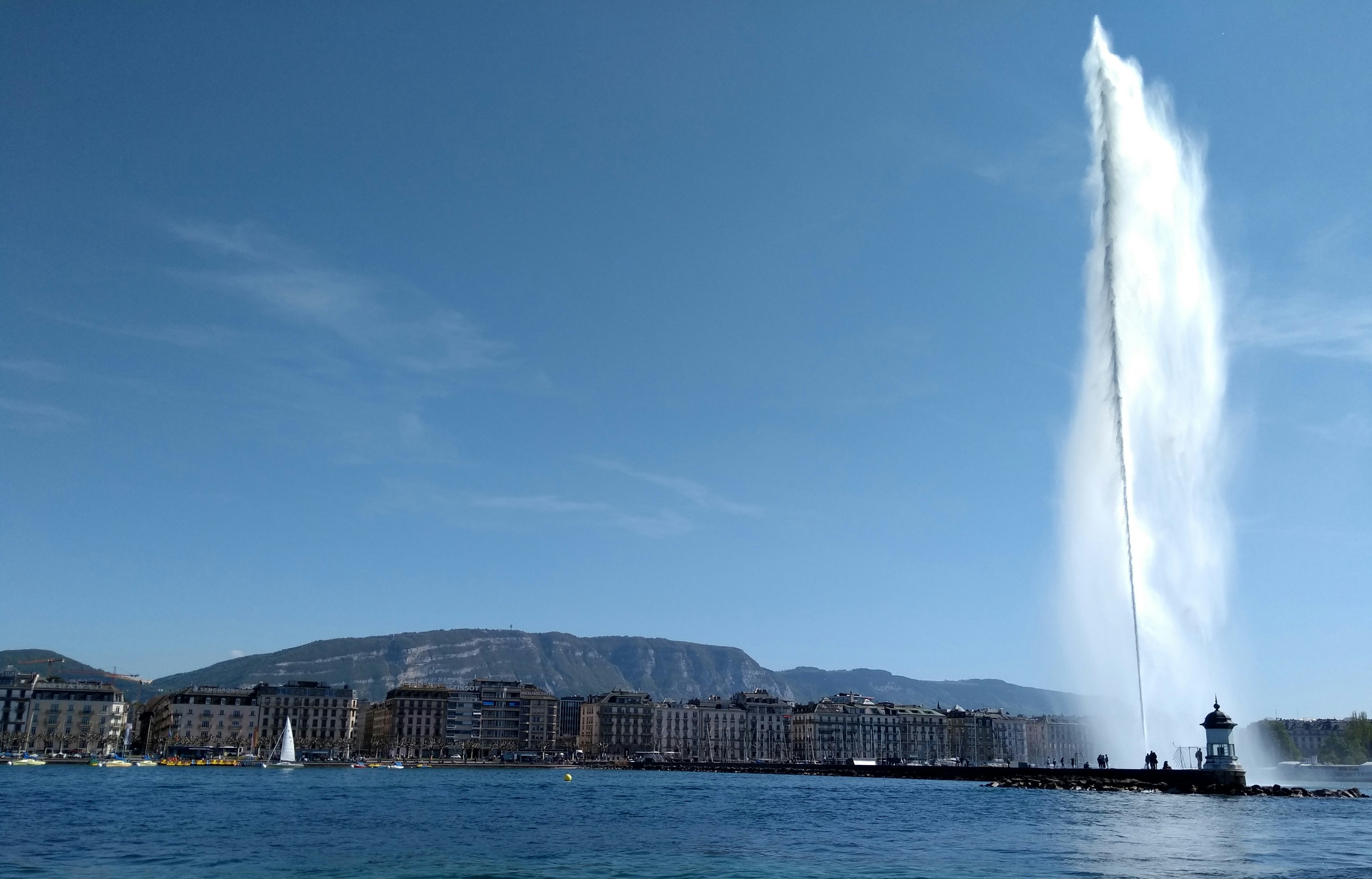 A large body of water with a large explosion in the distance photo ...