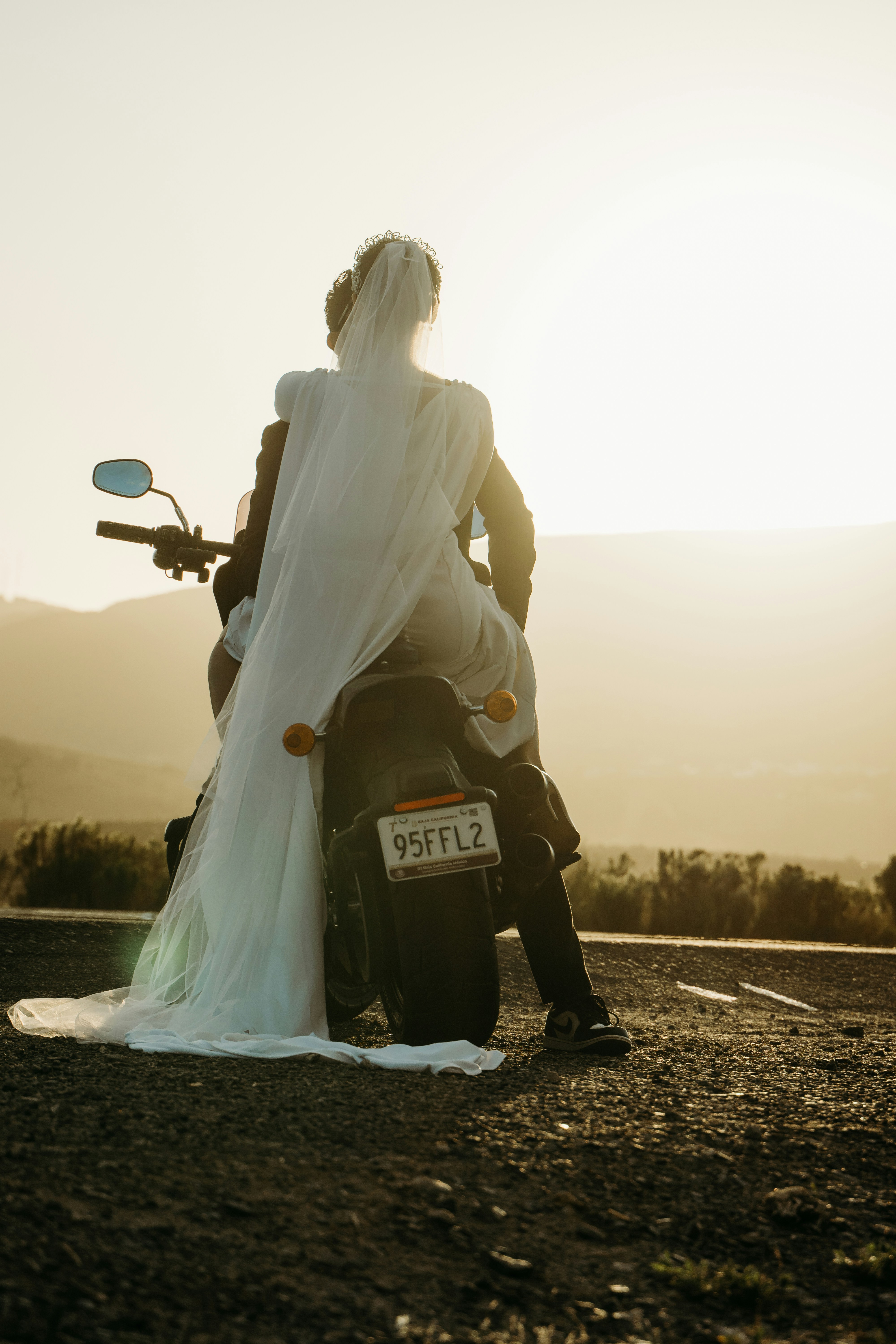 Golden Hour Vows: A Bride on a Motorcycle at Sunset