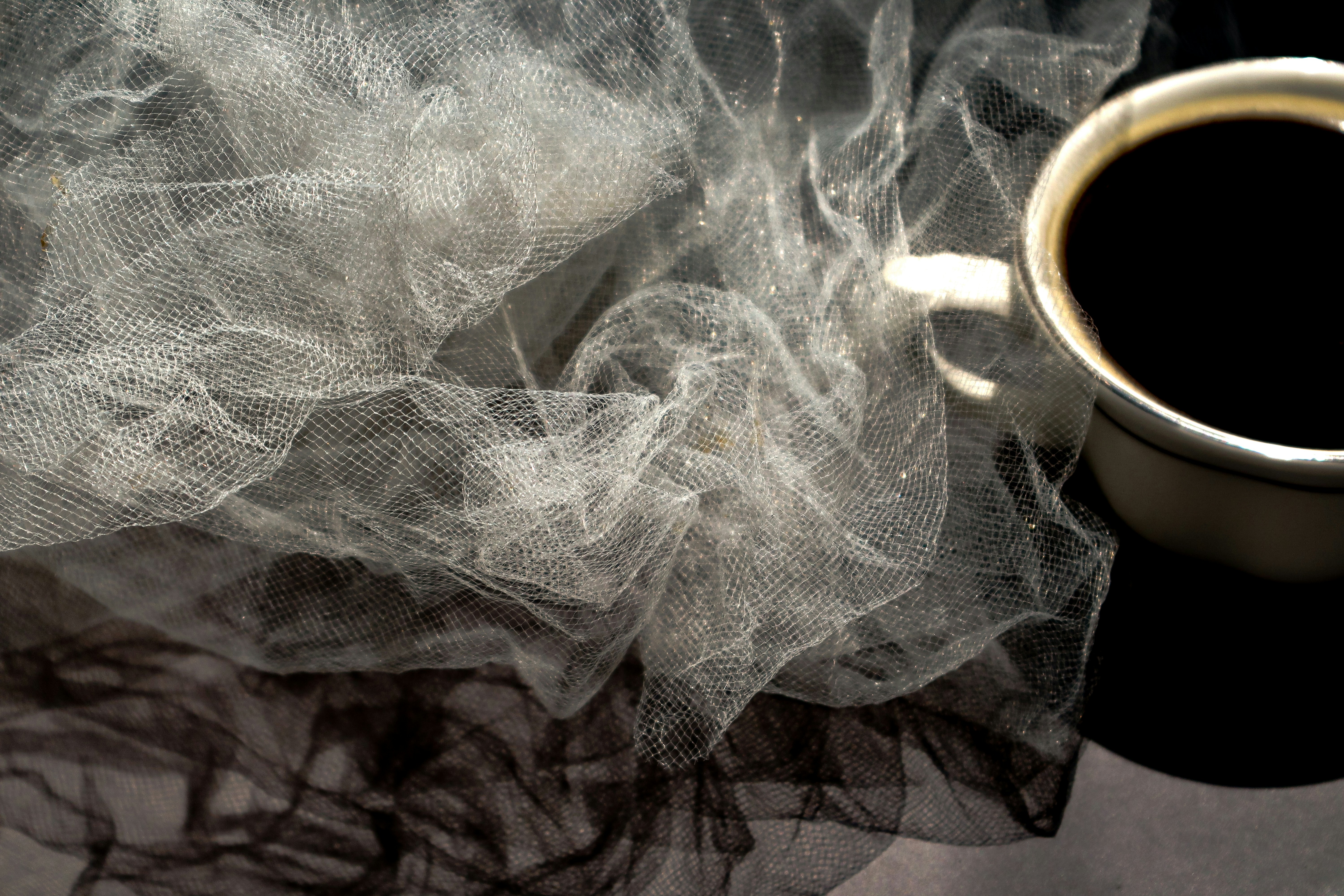 a cup of coffee next to a leaf