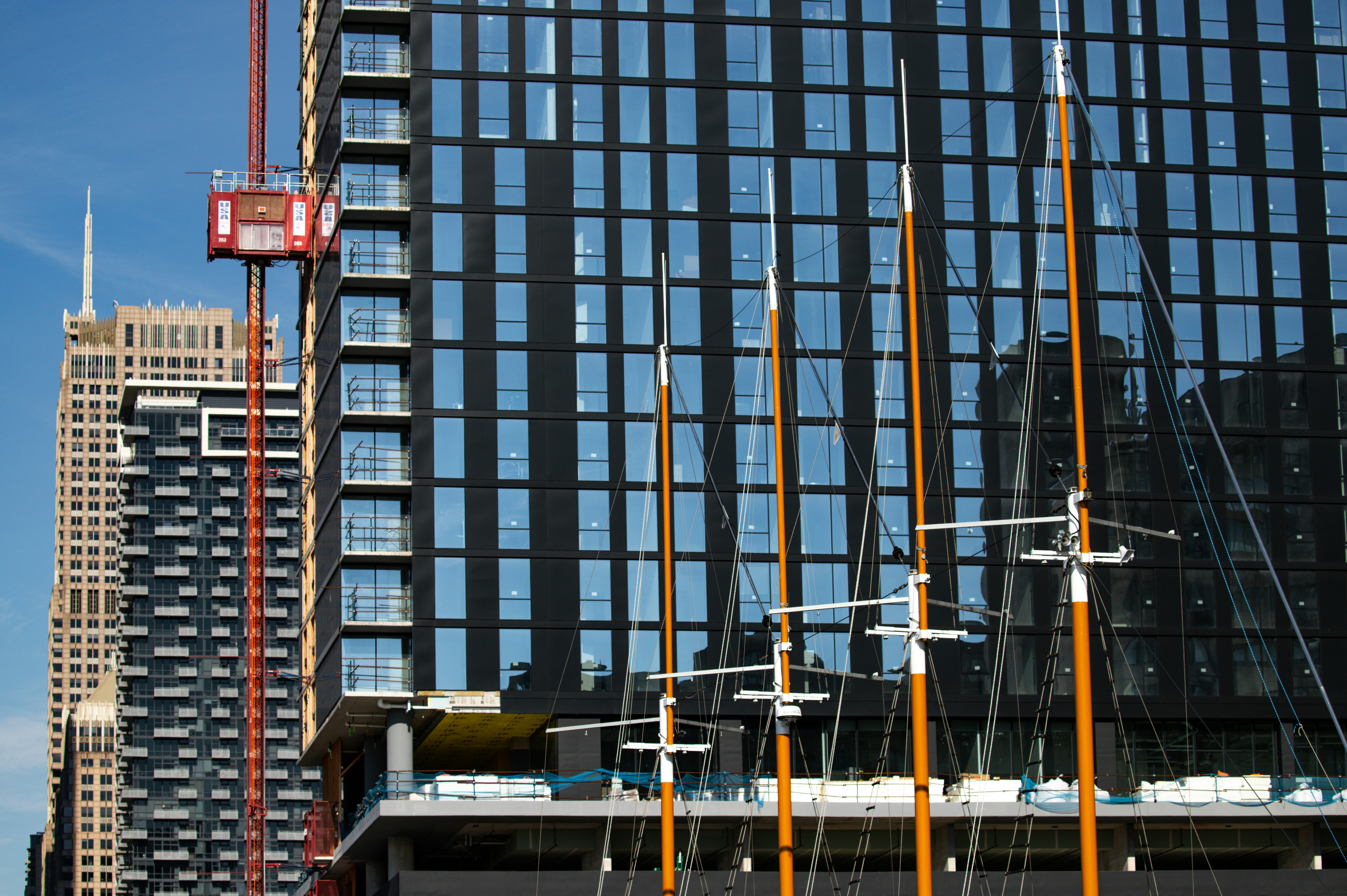 Harbor Masts Against a Glass Empire