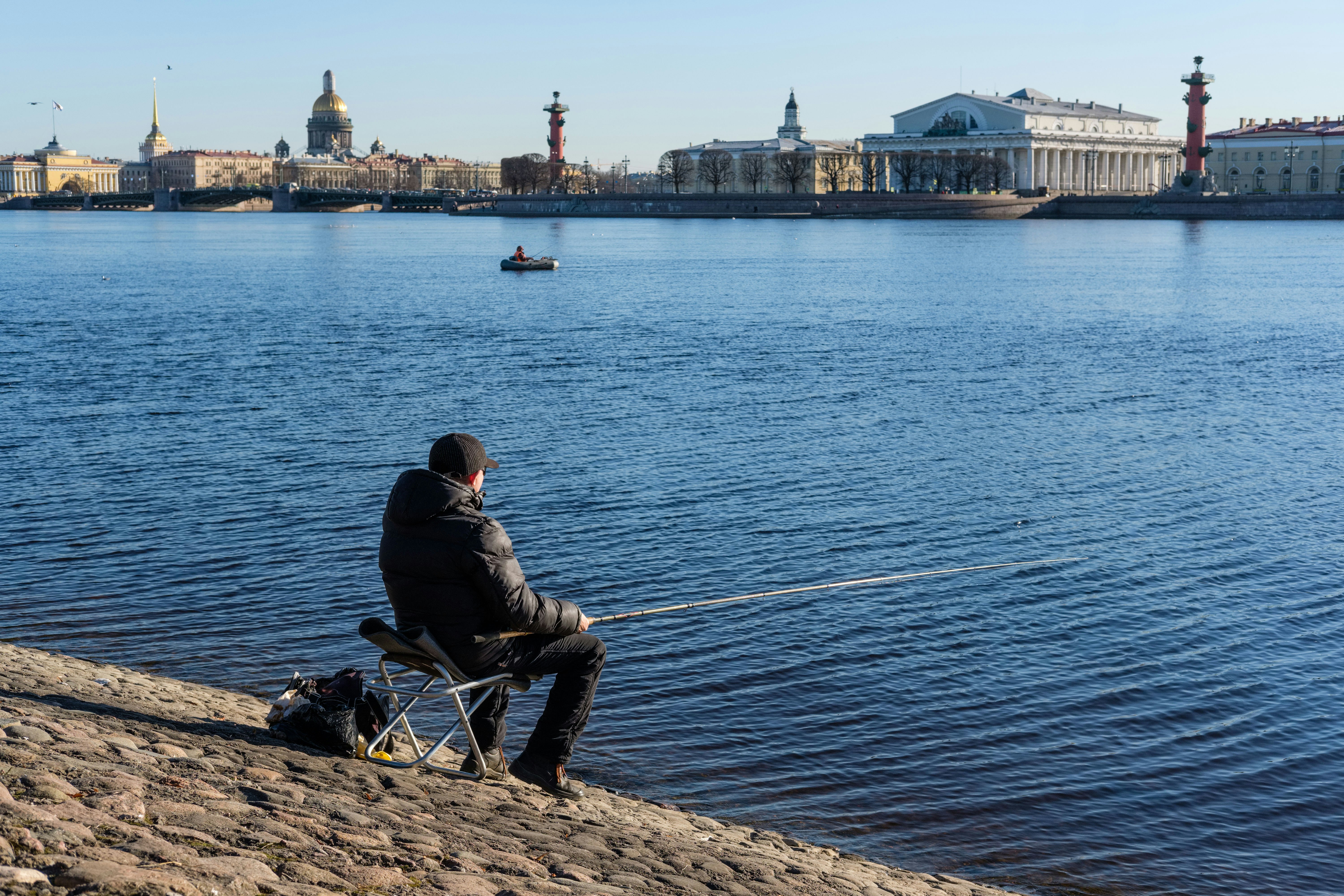 Quiet Cast Along the Neva: Fisherman at the Waterfront