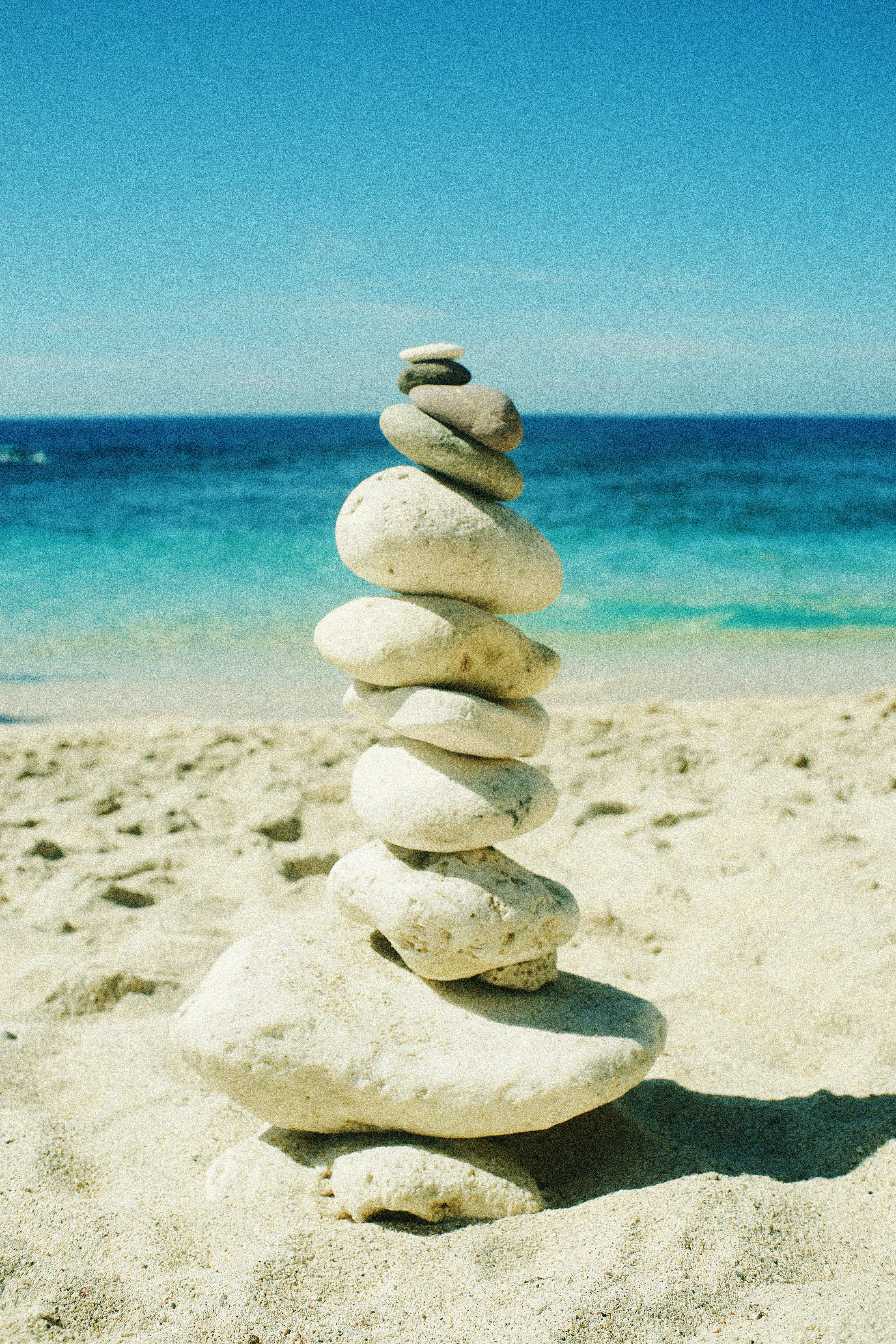 A stack of sand sculptures on a beach photo – Free Zambales Image on ...