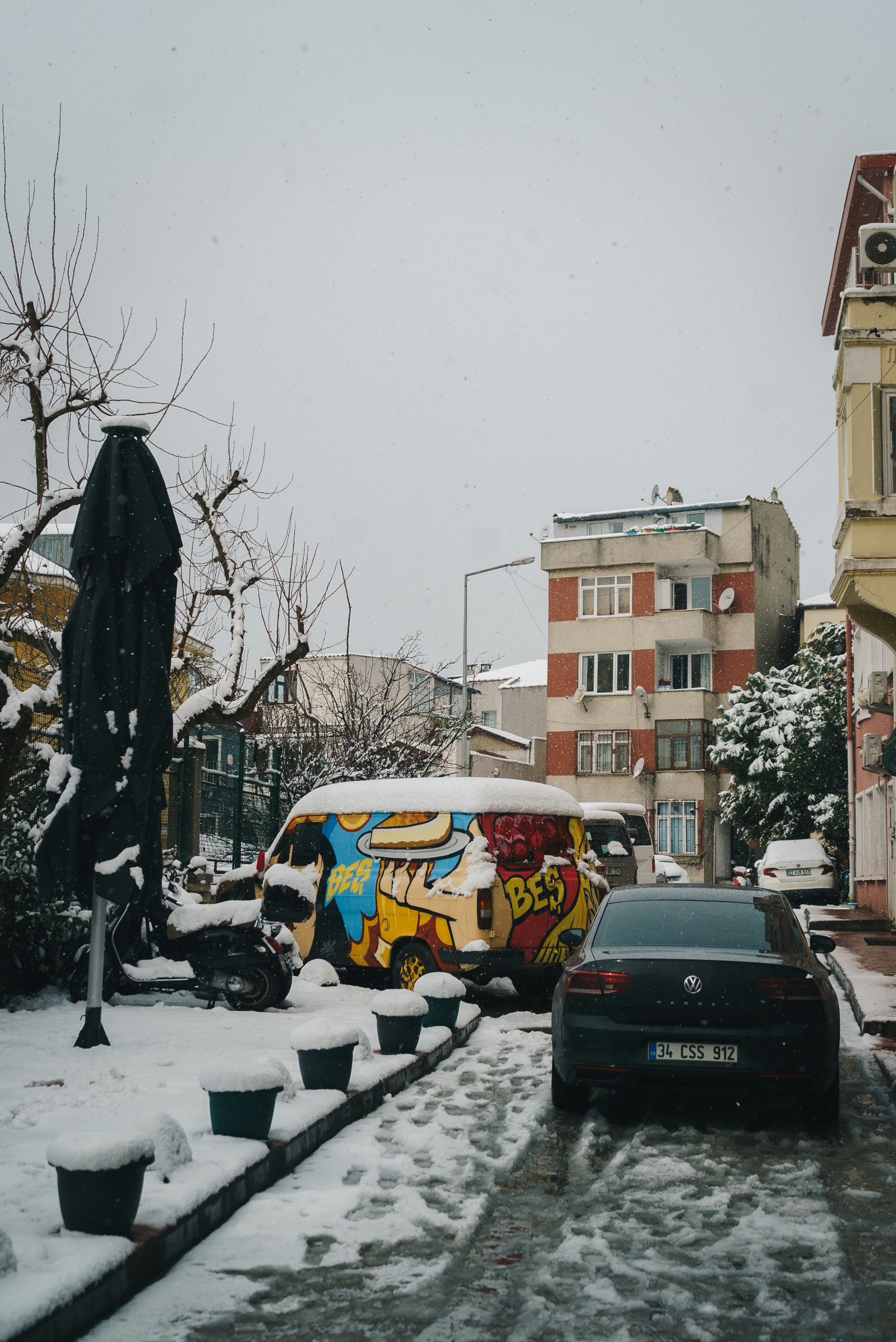 a van parked on the side of a road with snow on the ground