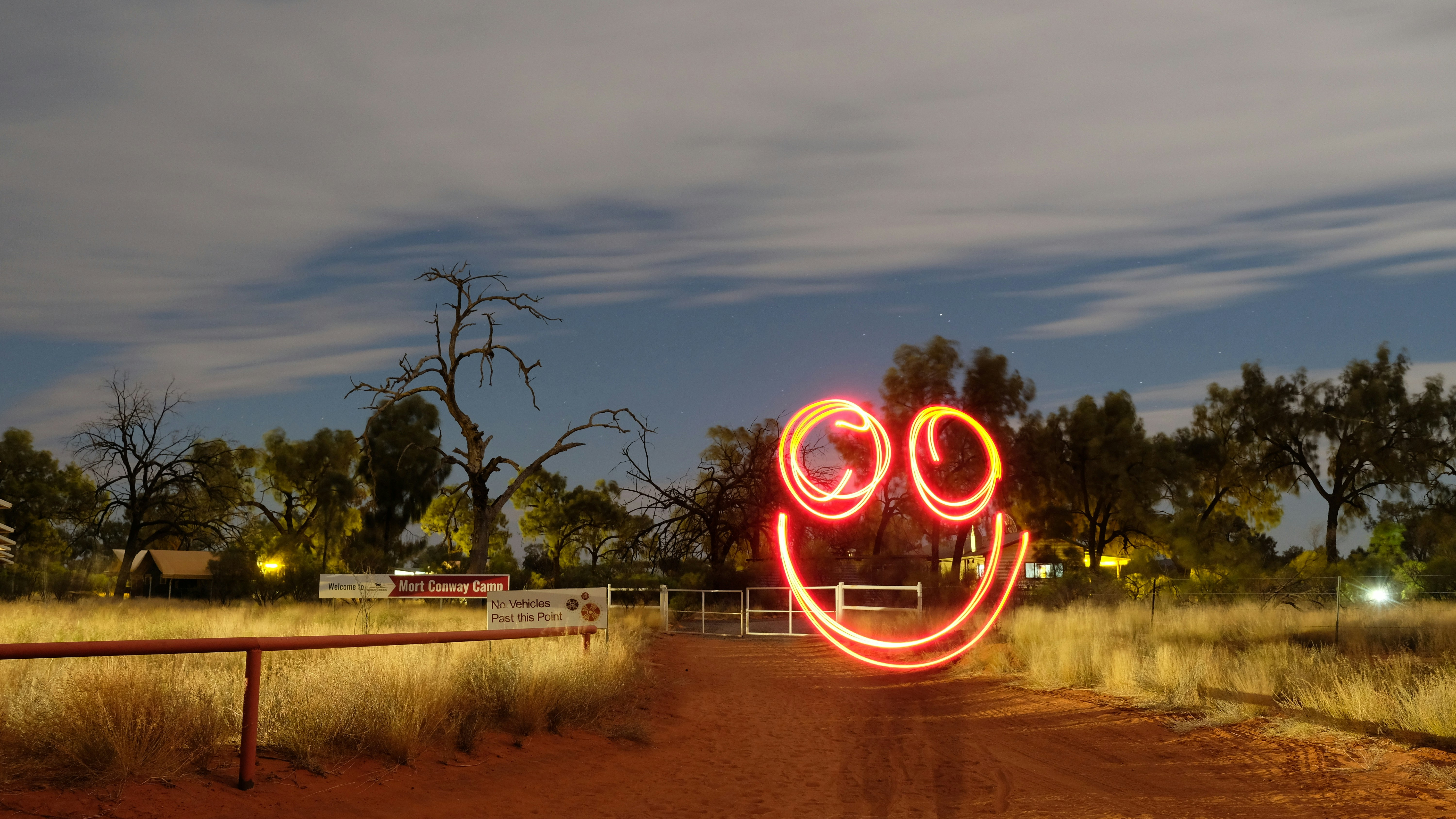 Neon Smile over the Dusty Road: A Night-Drawn Light-Painting
