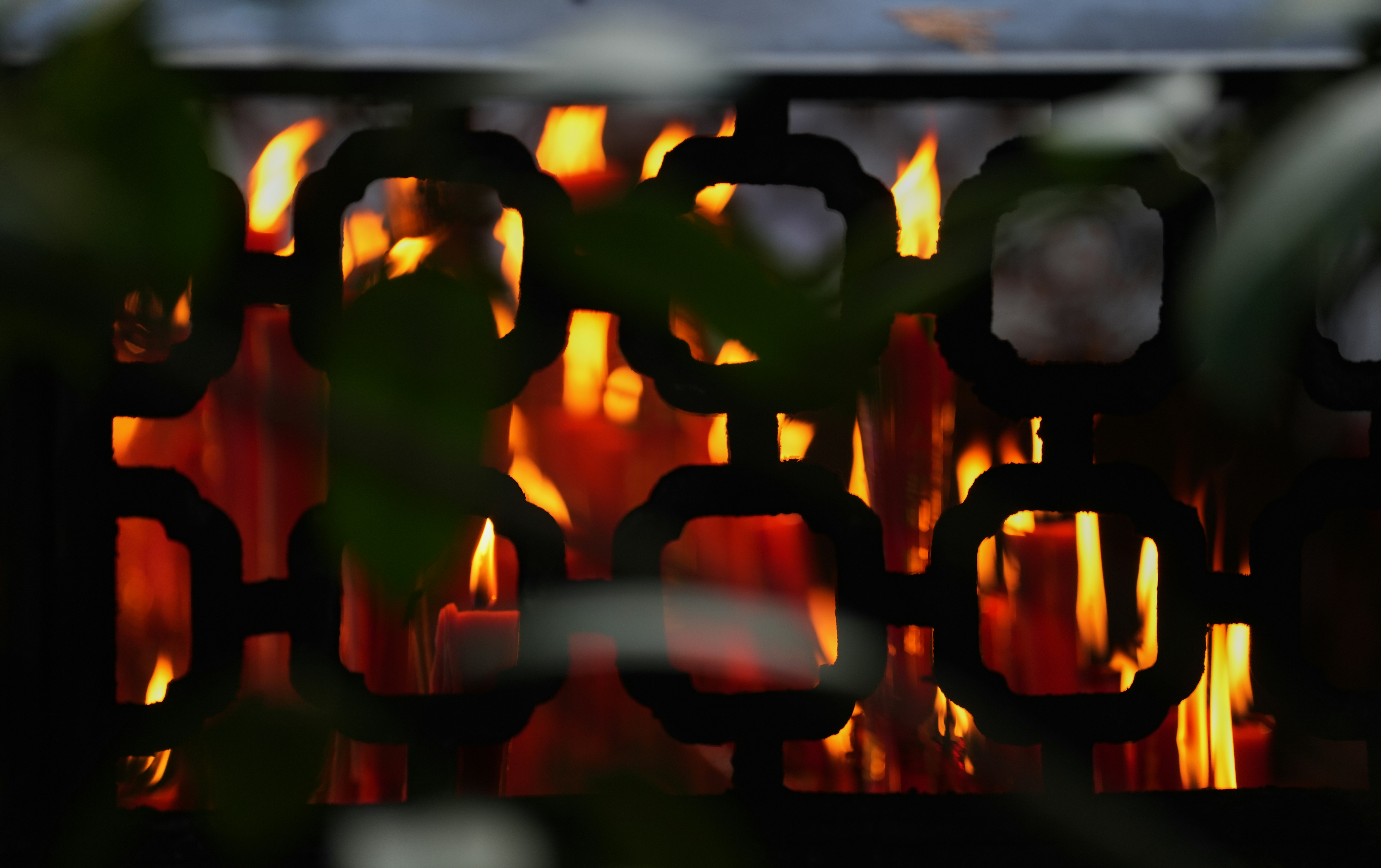 Inferno Behind Iron Veils: Firelight Filtered Through Geometric Grilles