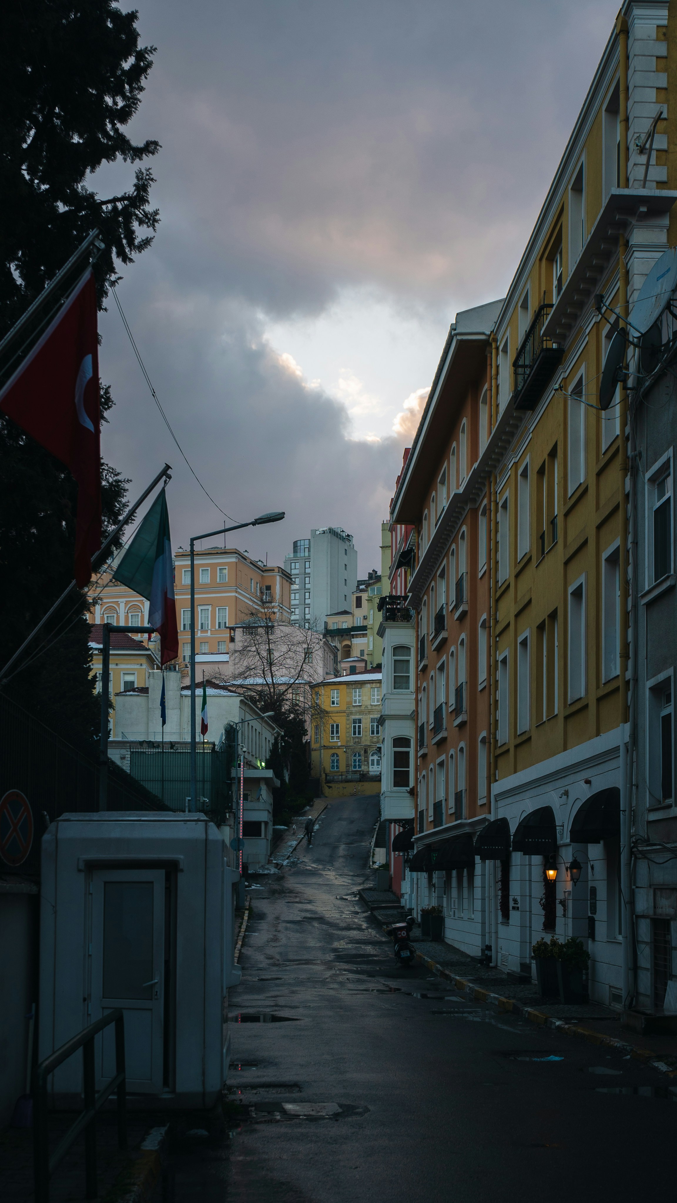 Dusk Up the Hill: Colorful Facades and Flags on an Istanbul Street