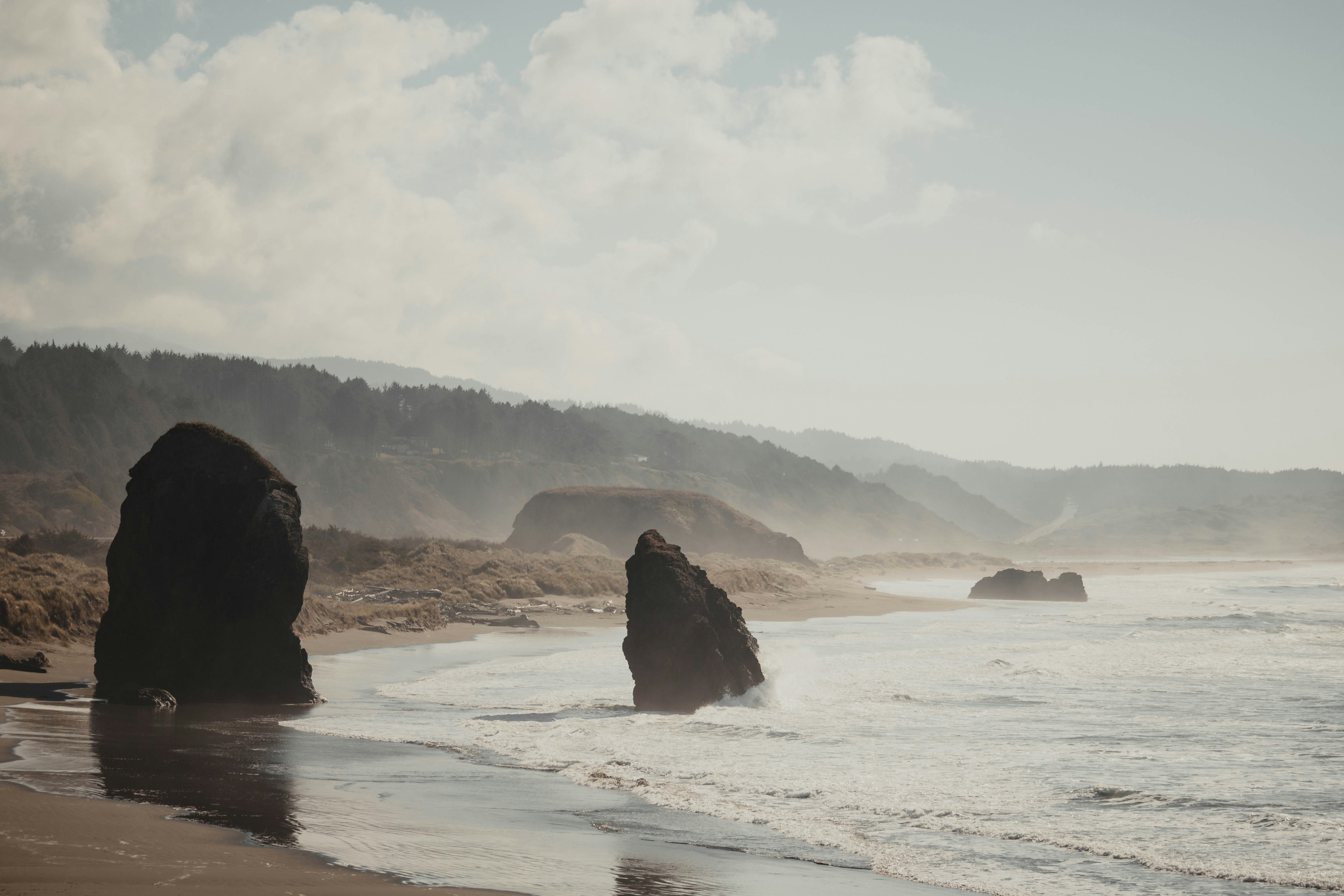 A group of rocks in the water photo – Free Pnw coast Image on Unsplash