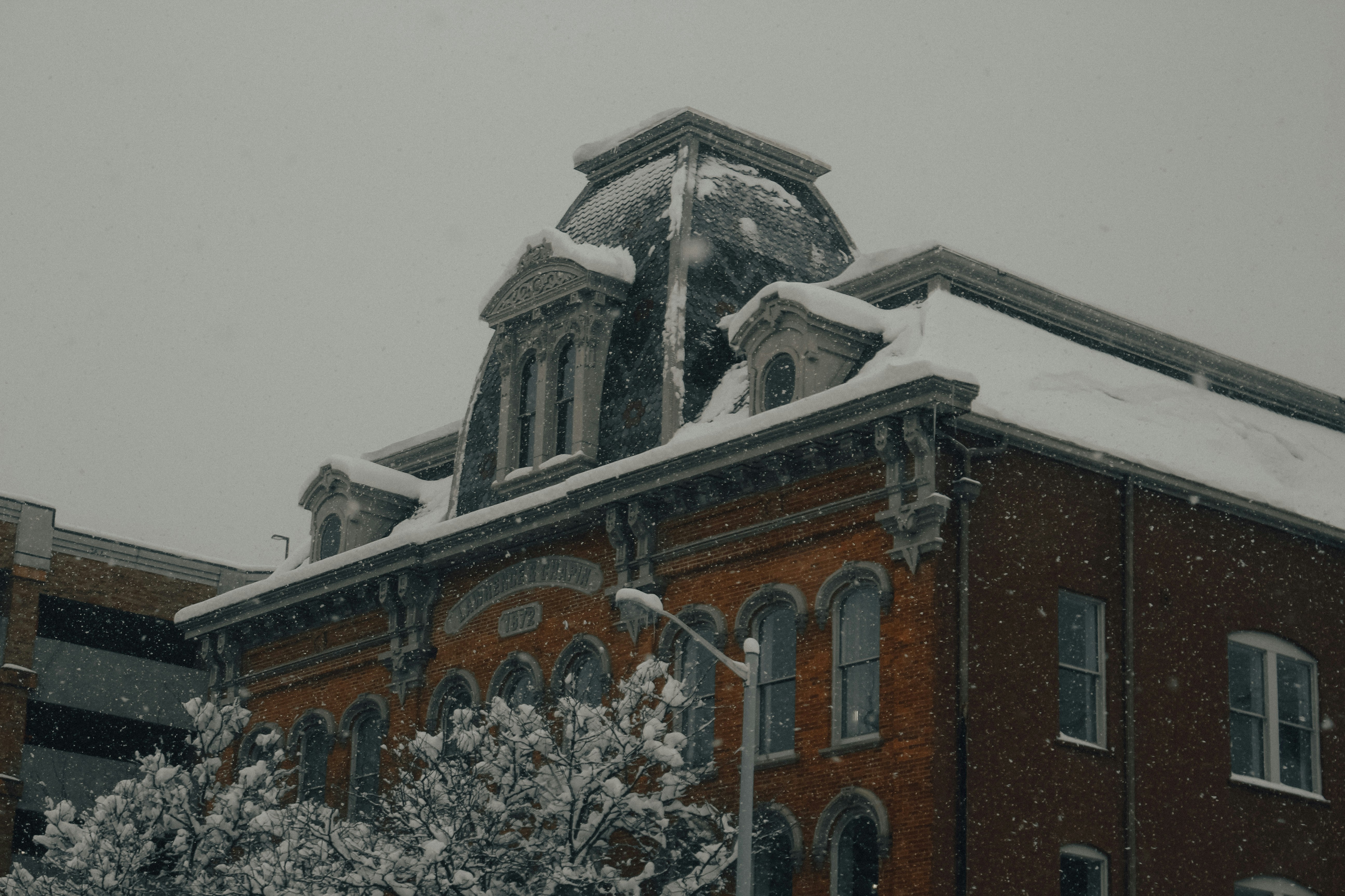 A brick building with snow on the roof photo – Free Outdoors Image on ...