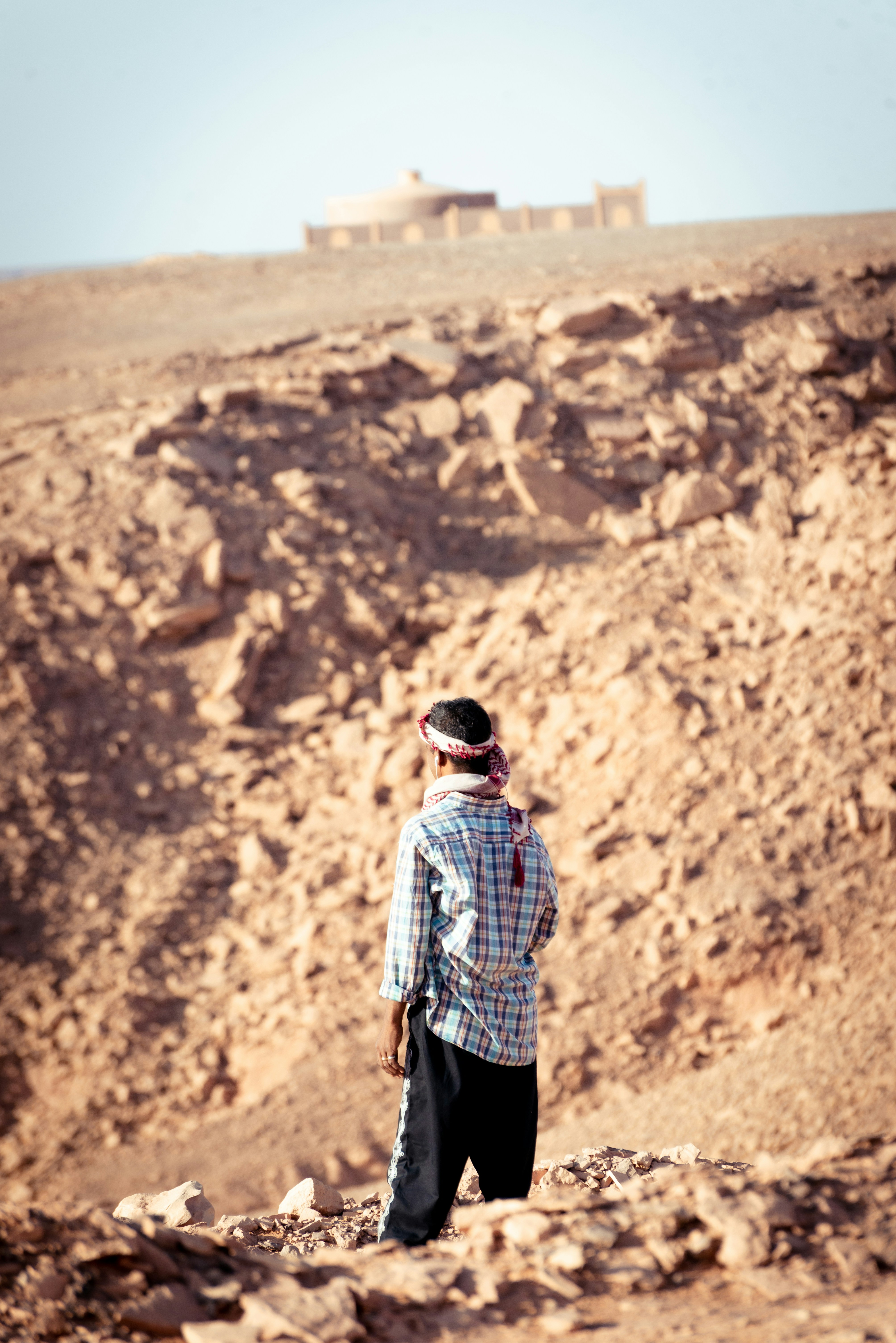 Lone Traveler at the Desert Edge: Distant Outpost on the Horizon