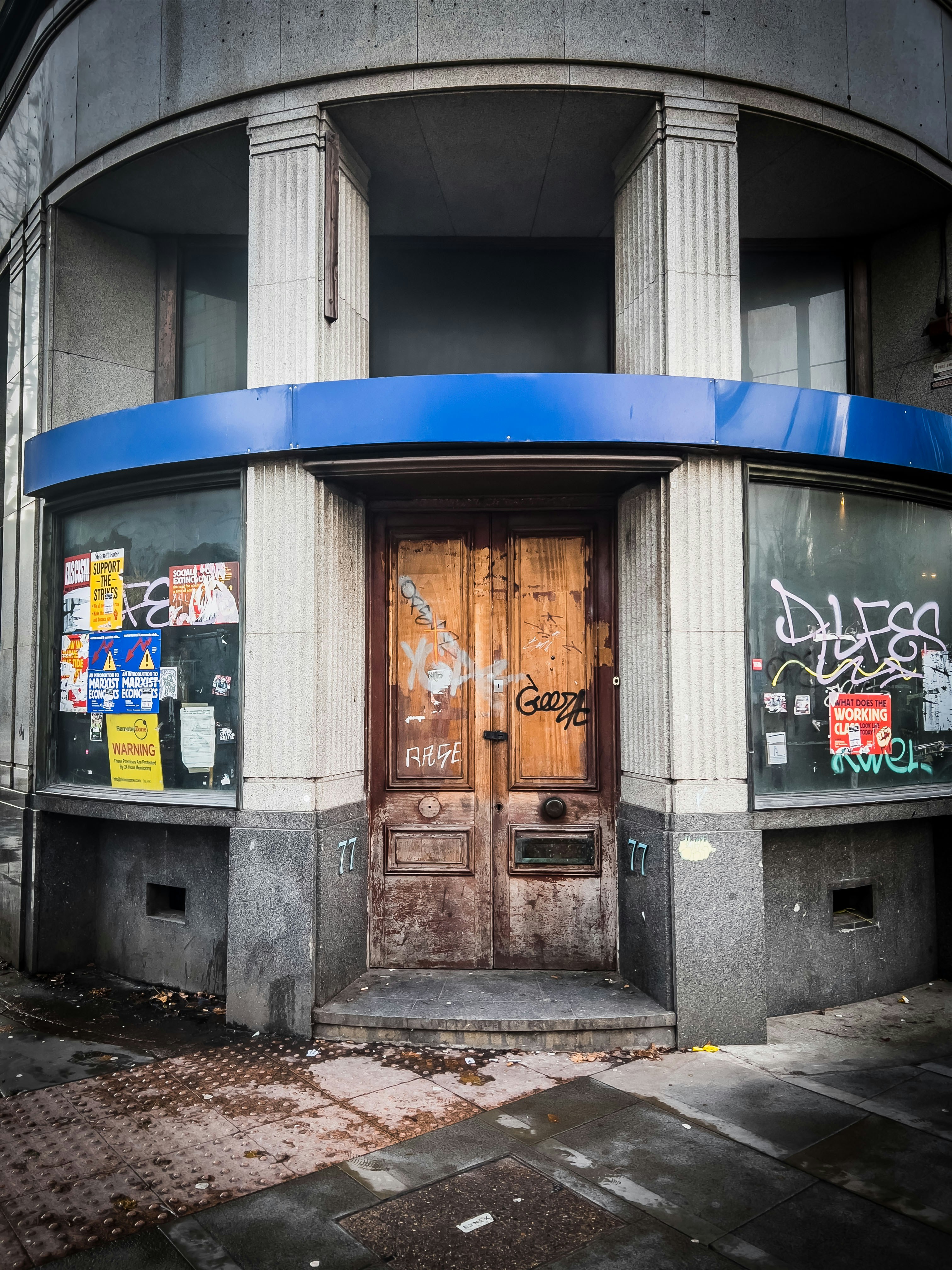 Weathered storefront doorway framed by concrete columns