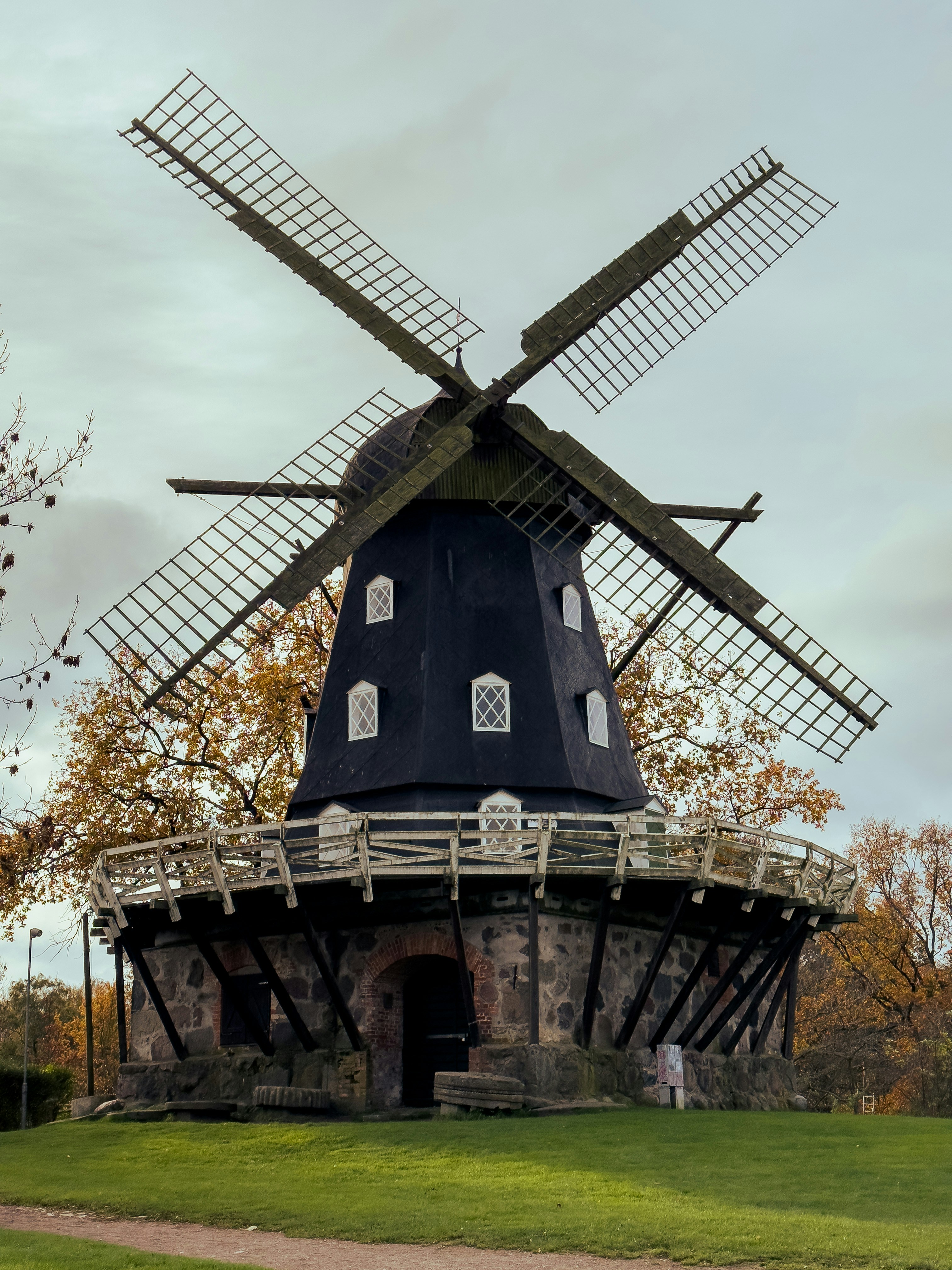 Windmill on a Stone Base Amid Autumn Light