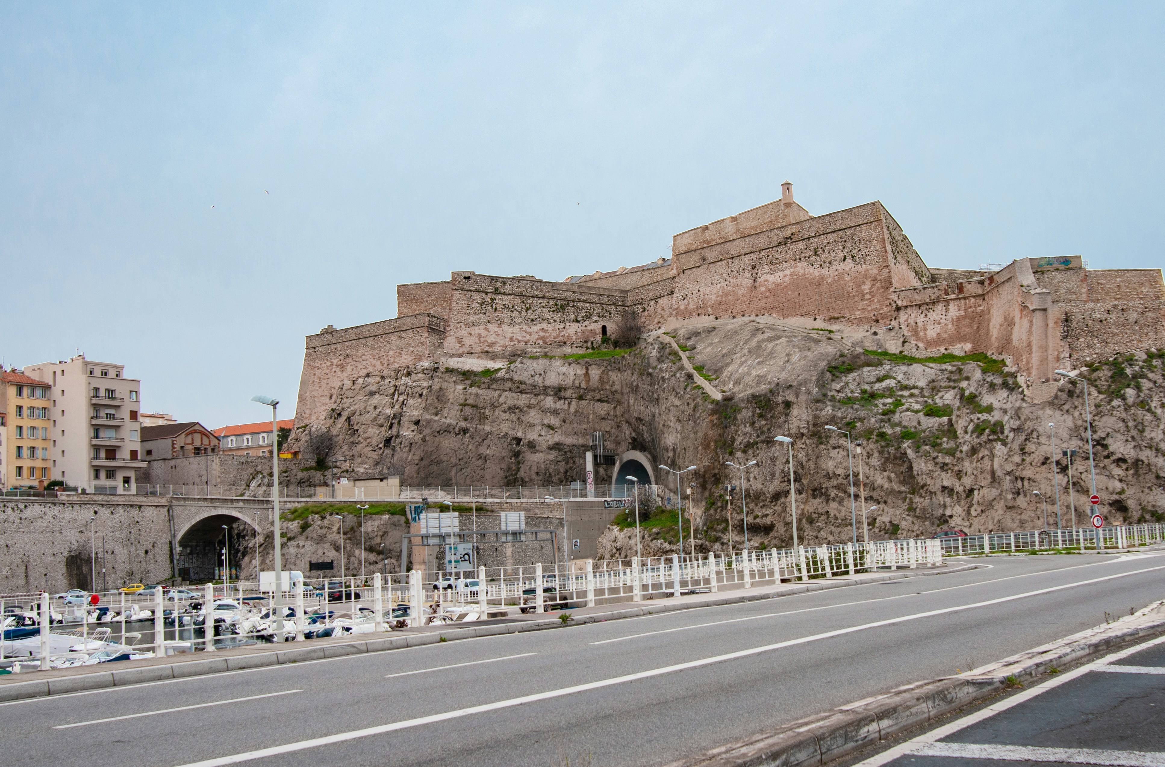 a road with a large rock structure on the side