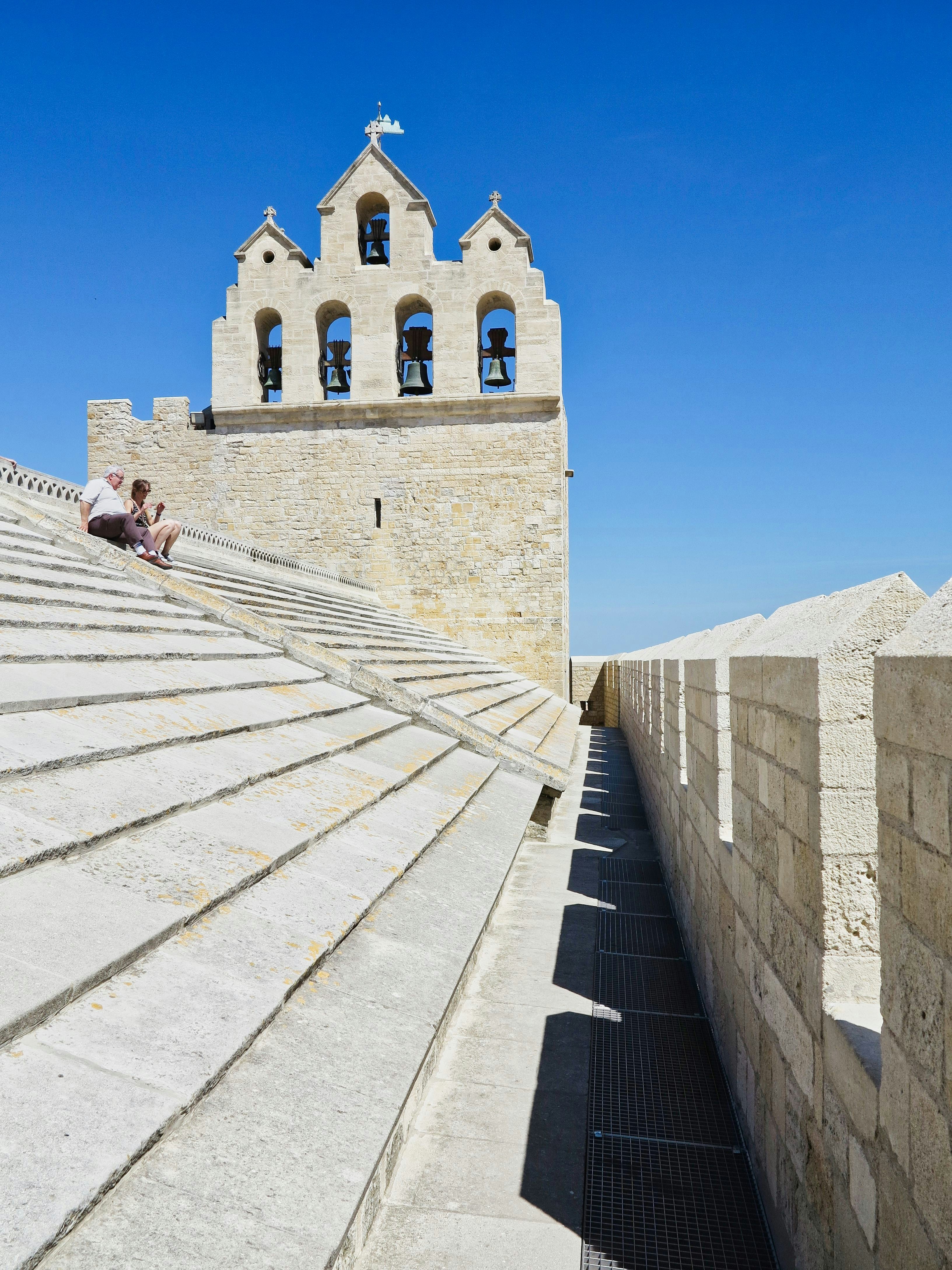 Sunlit Bell Tower Rising Over the Limestone Steps