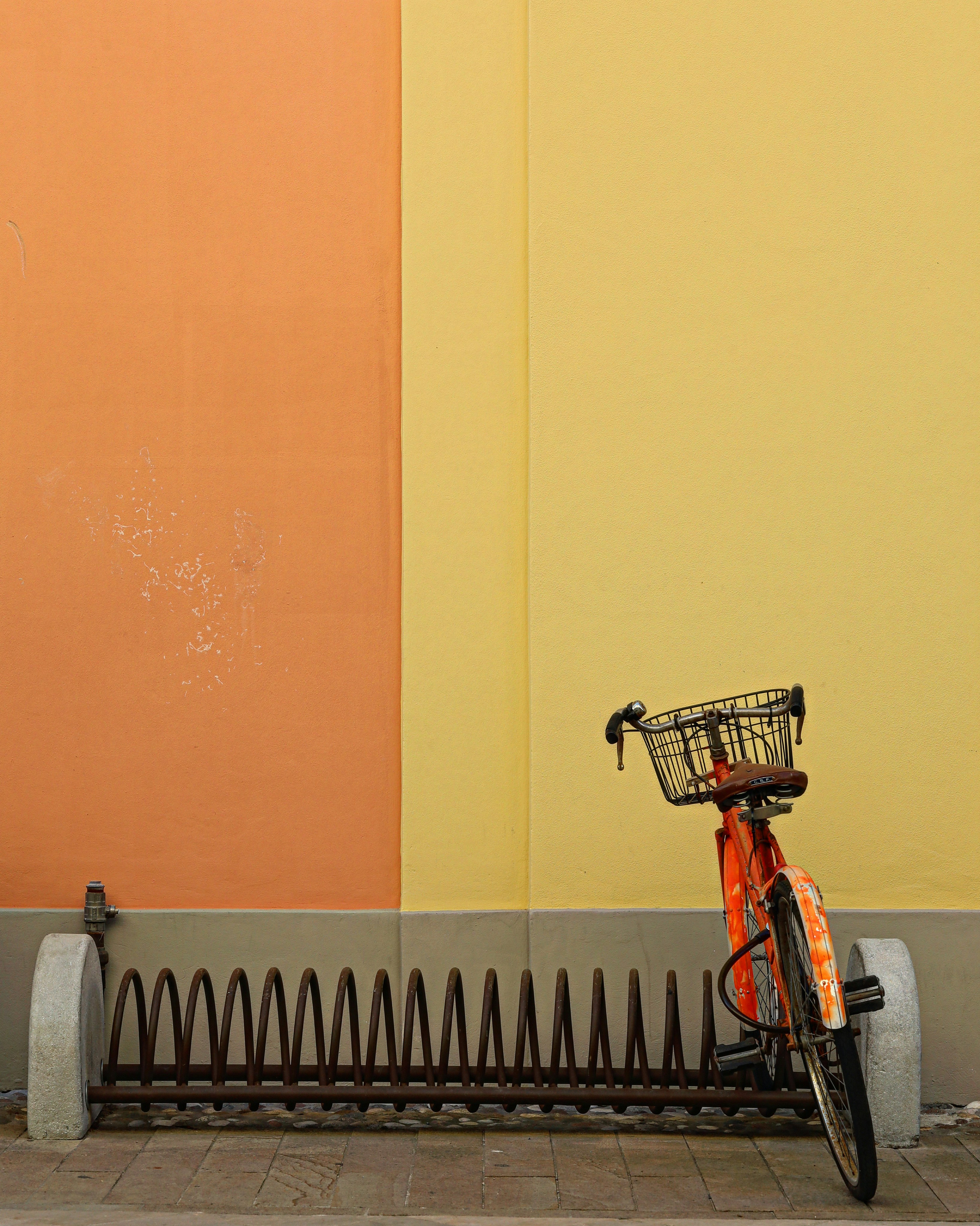 Crimson Bicycle Framed by a Two-Tone Sunset Wall