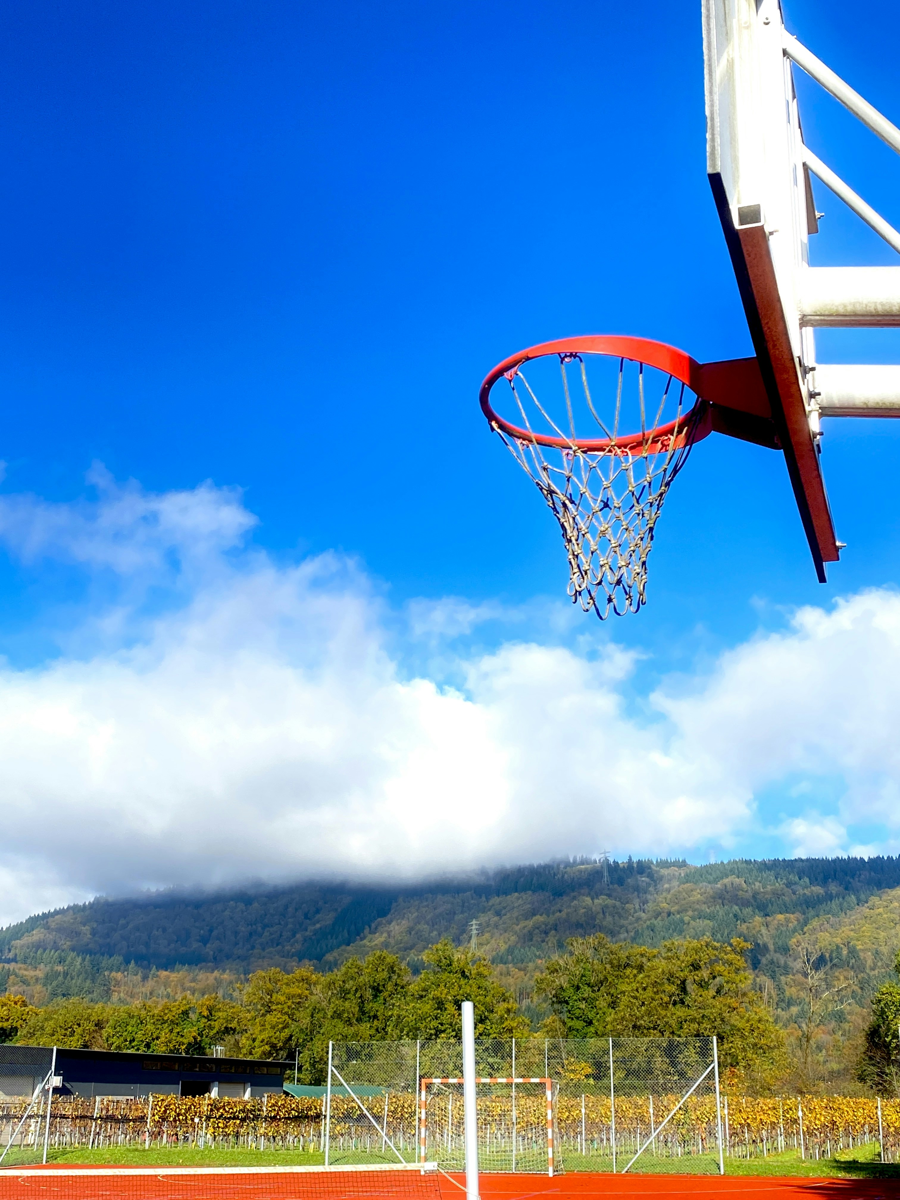 Hoop in the Cerulean Sky: A Quiet Outdoor Court by the Hills
