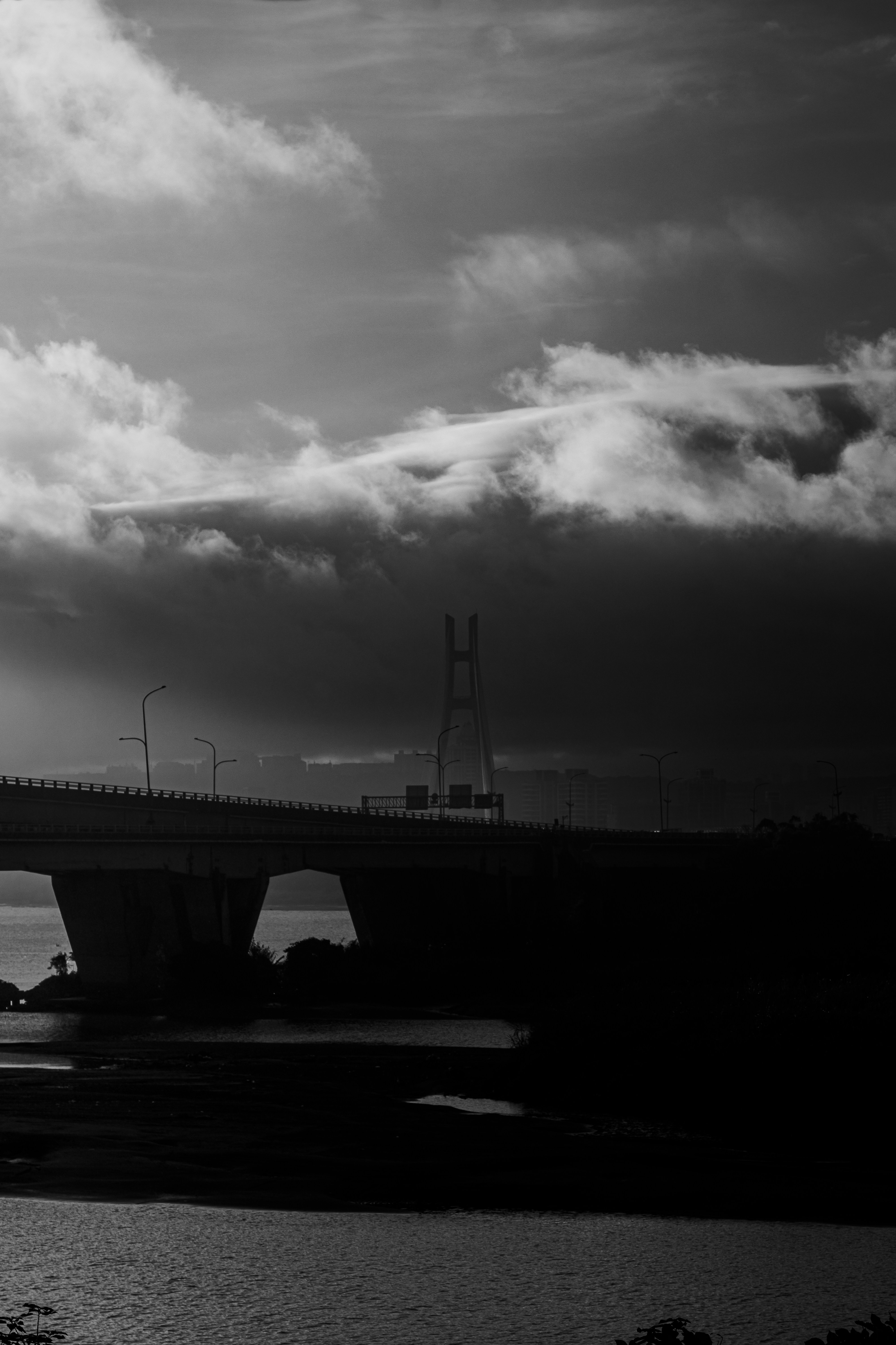 Midnight Span: A Quiet Bridge Under a Looming Sky