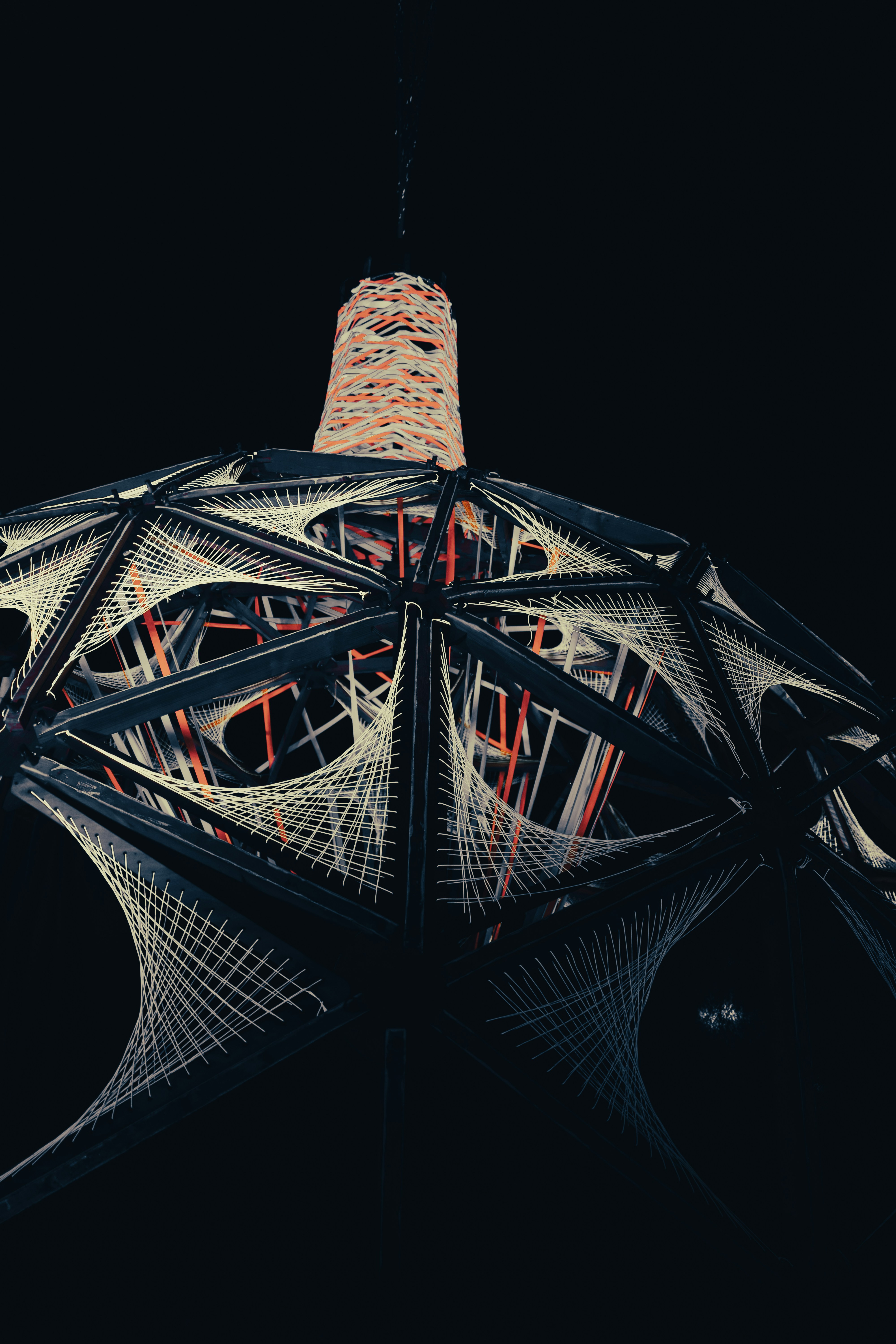 Luminous Spire: A Nighttime Structure Illuminated in Geometric Threads