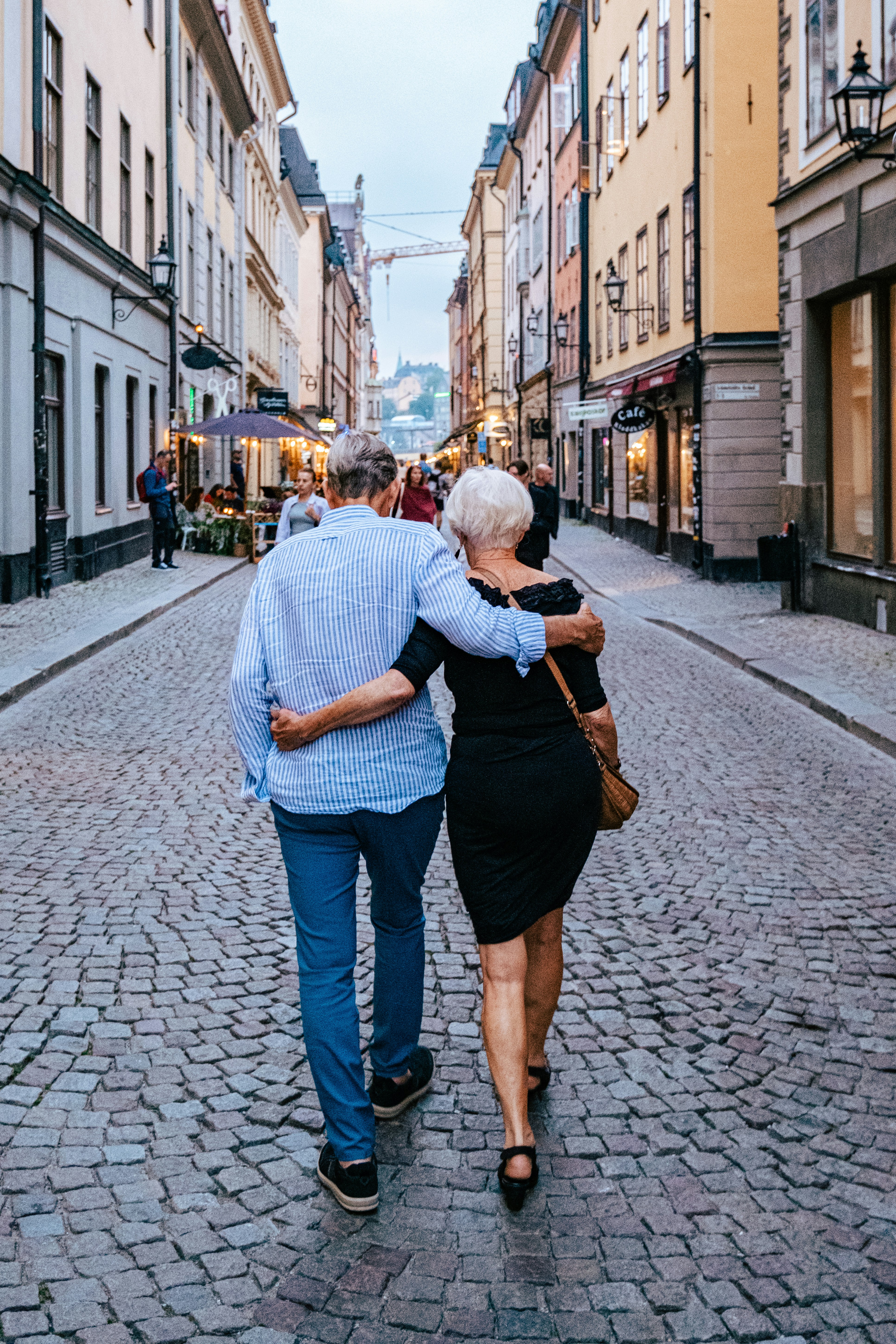 Holding Tight on Cobblestones: A Shared Sunset Walk Down a European Street