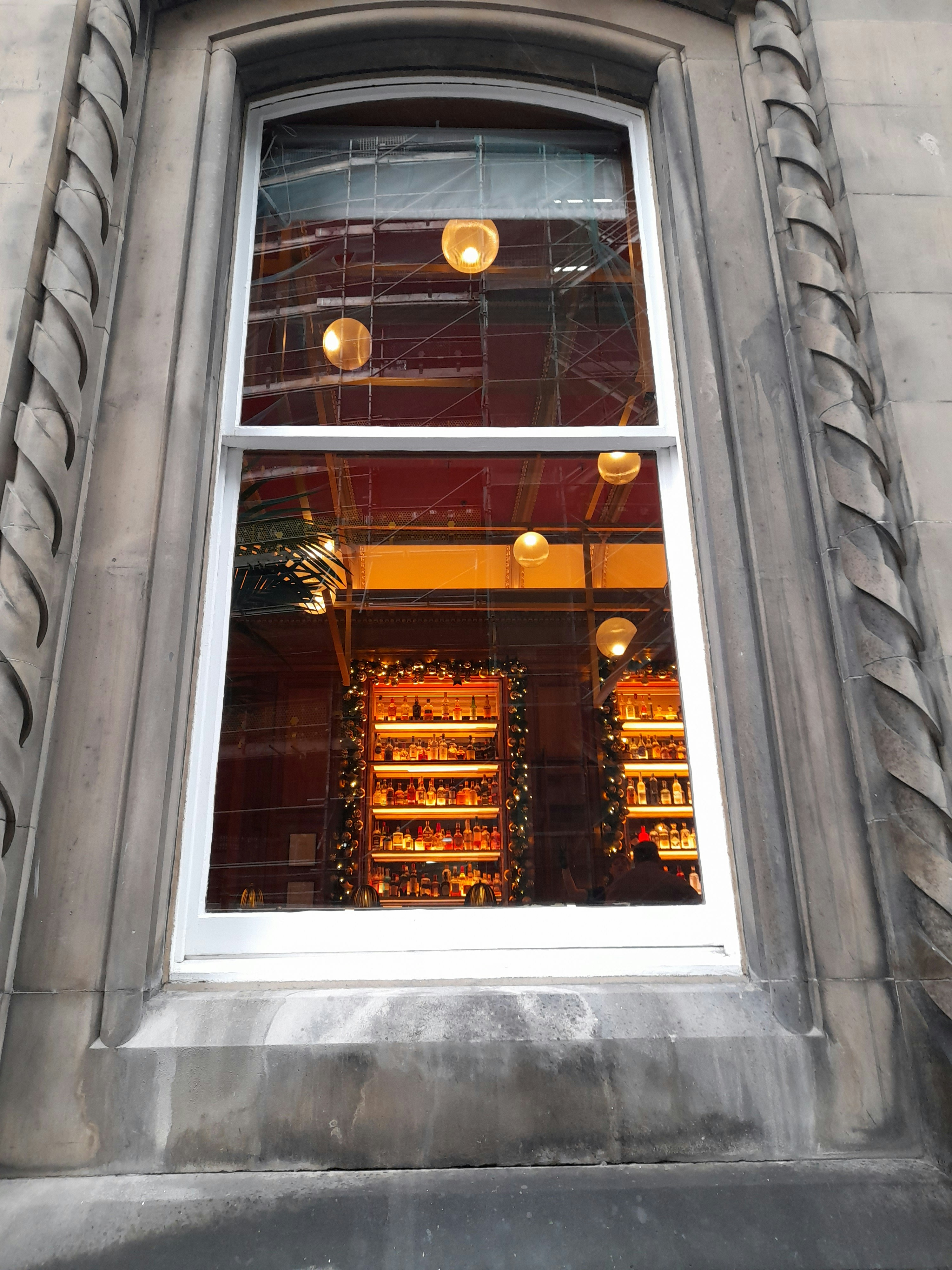 Warm Interior Reflections Through a City Window