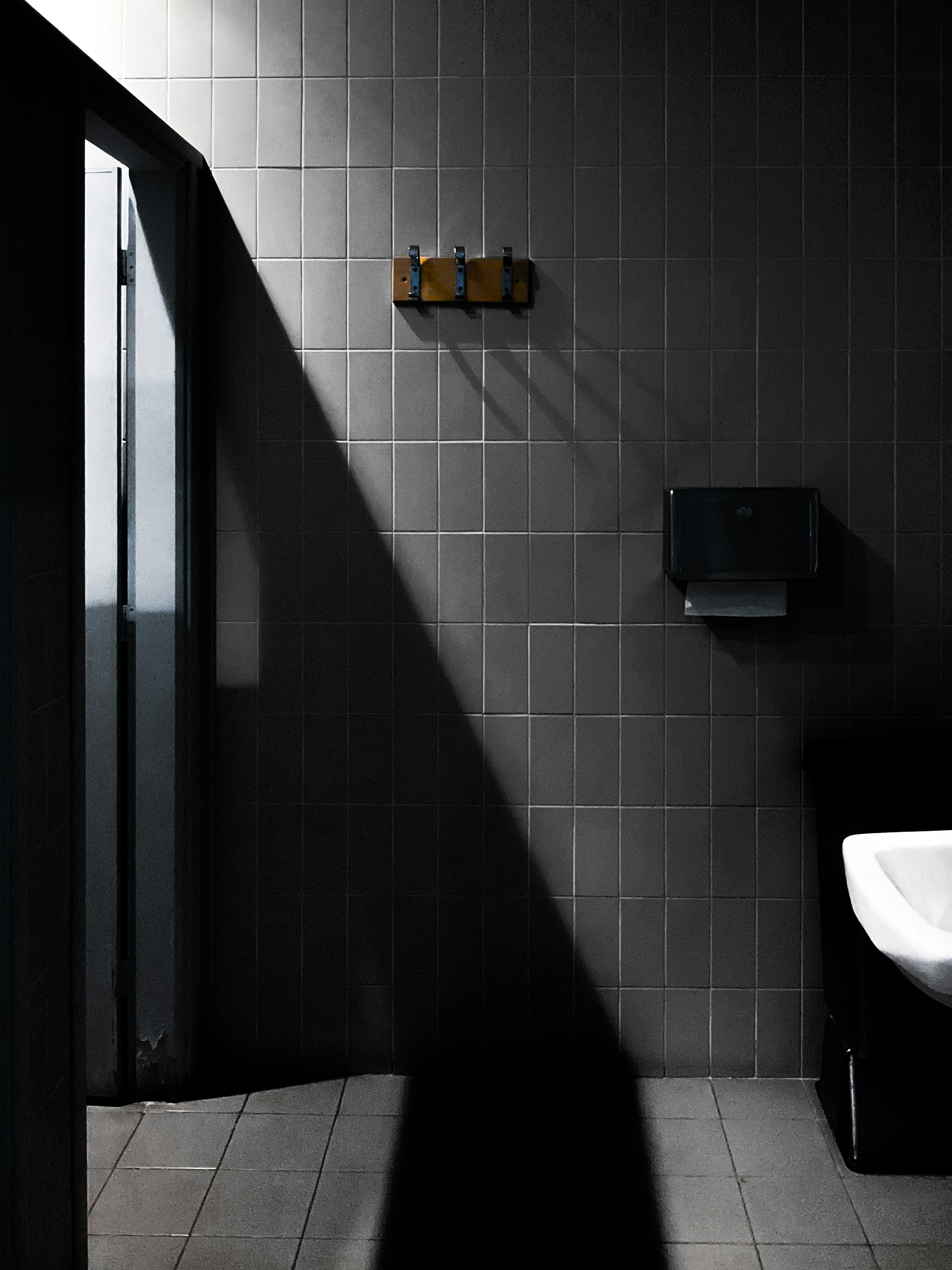 A shadow of a person on a tile wall photo – Free Floor Image on Unsplash