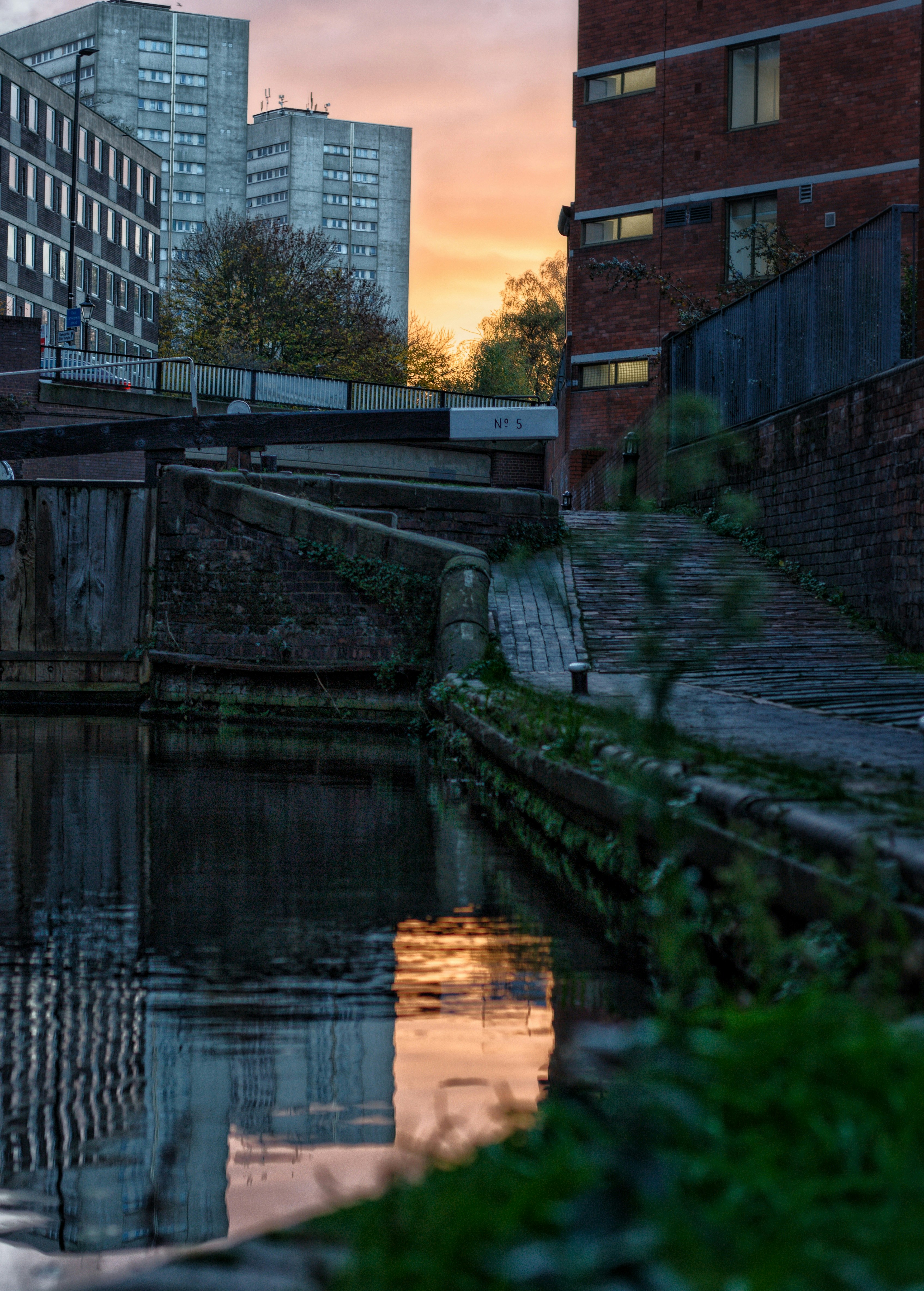 Sunset Over the Canal Between Brick Facades