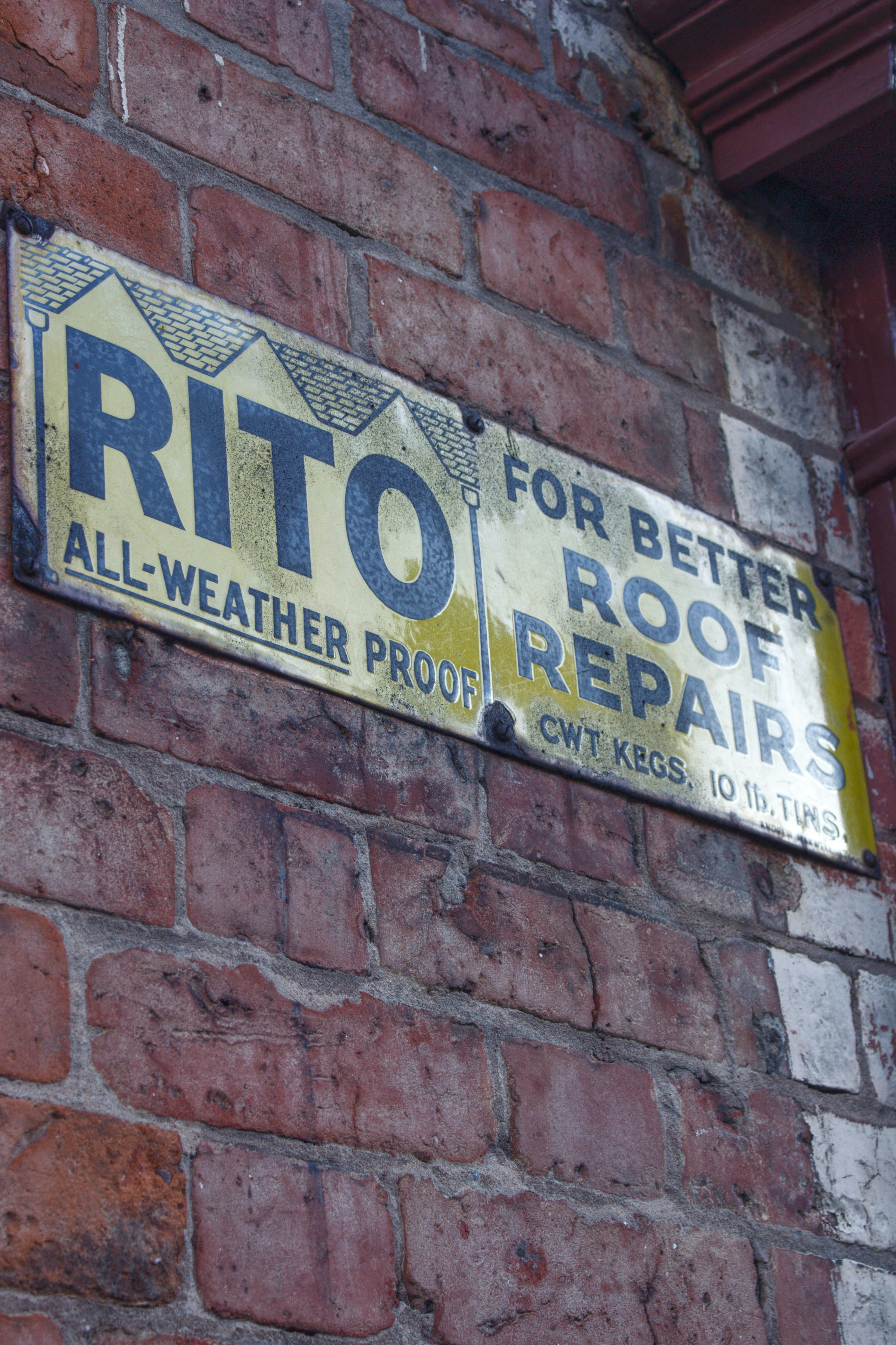 a sign on a brick wall