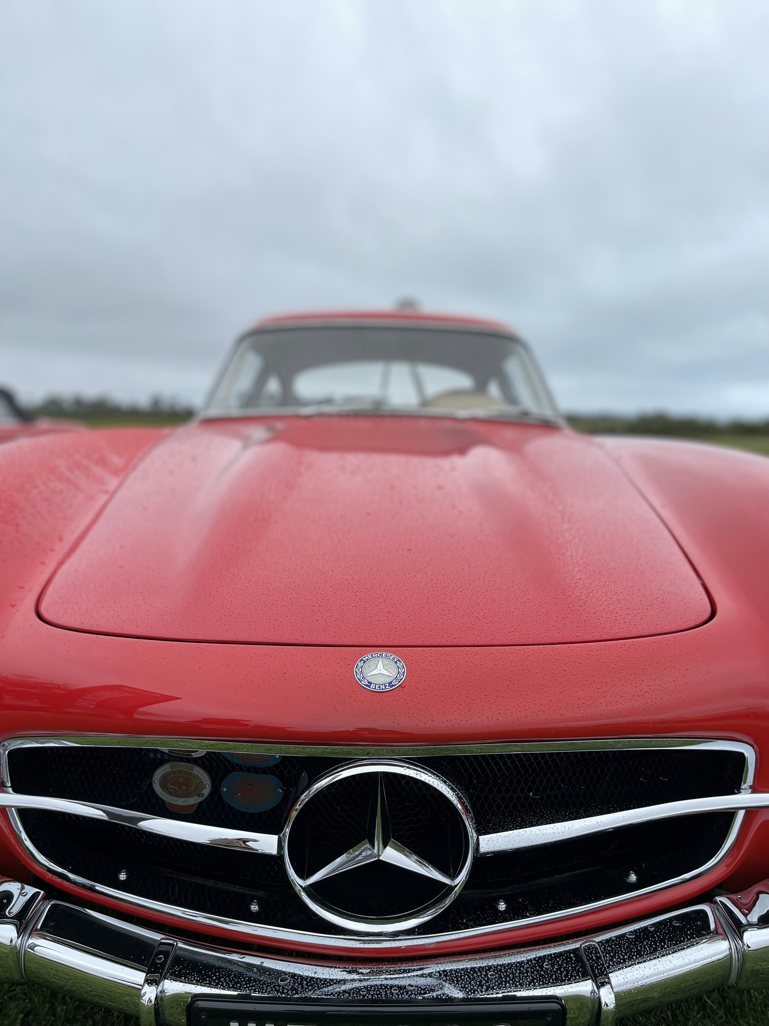 Red Mercedes Front End: Rain-Kissed Hood and Chrome Grille