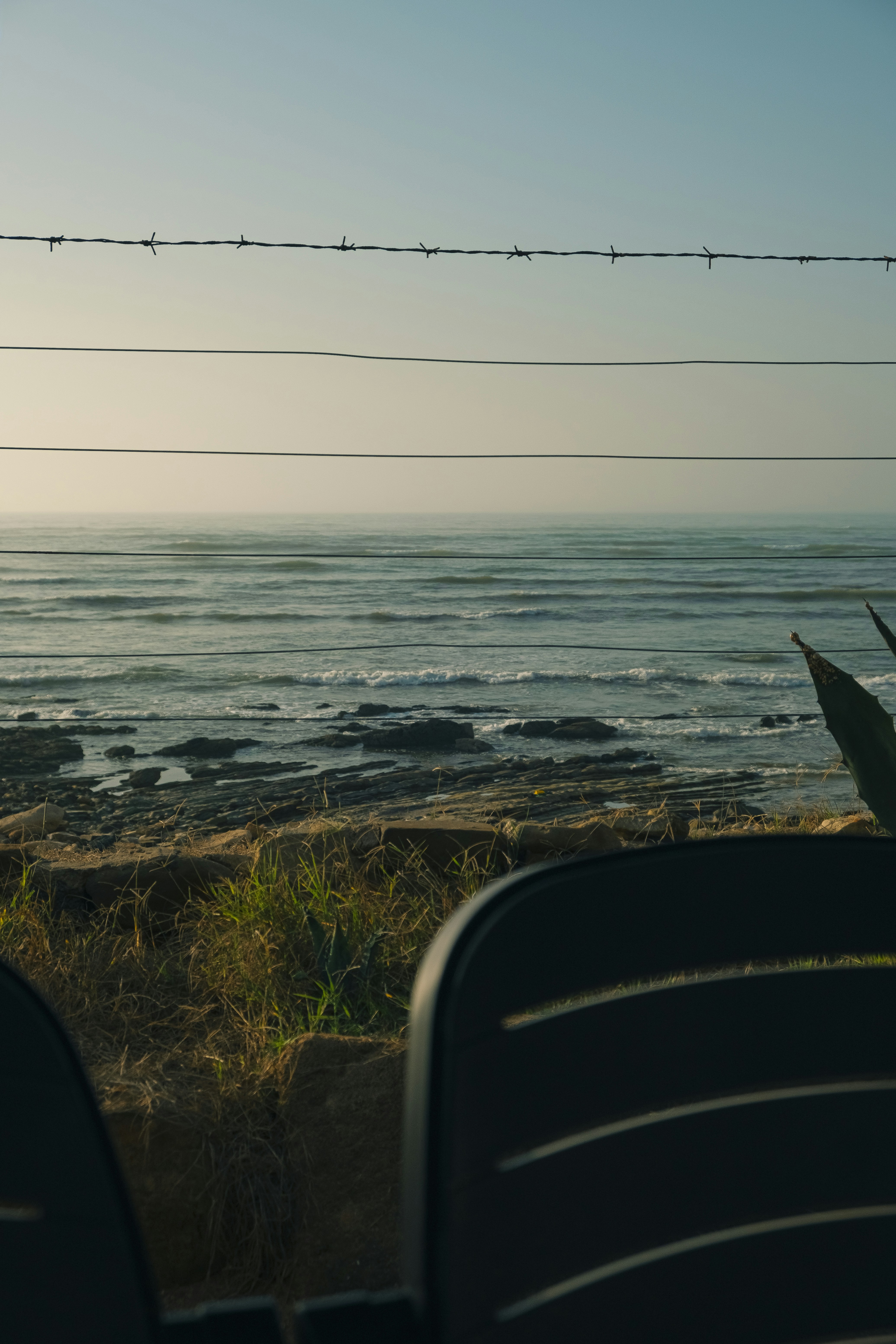 Seaside View Through a Vehicle Window at Dusk