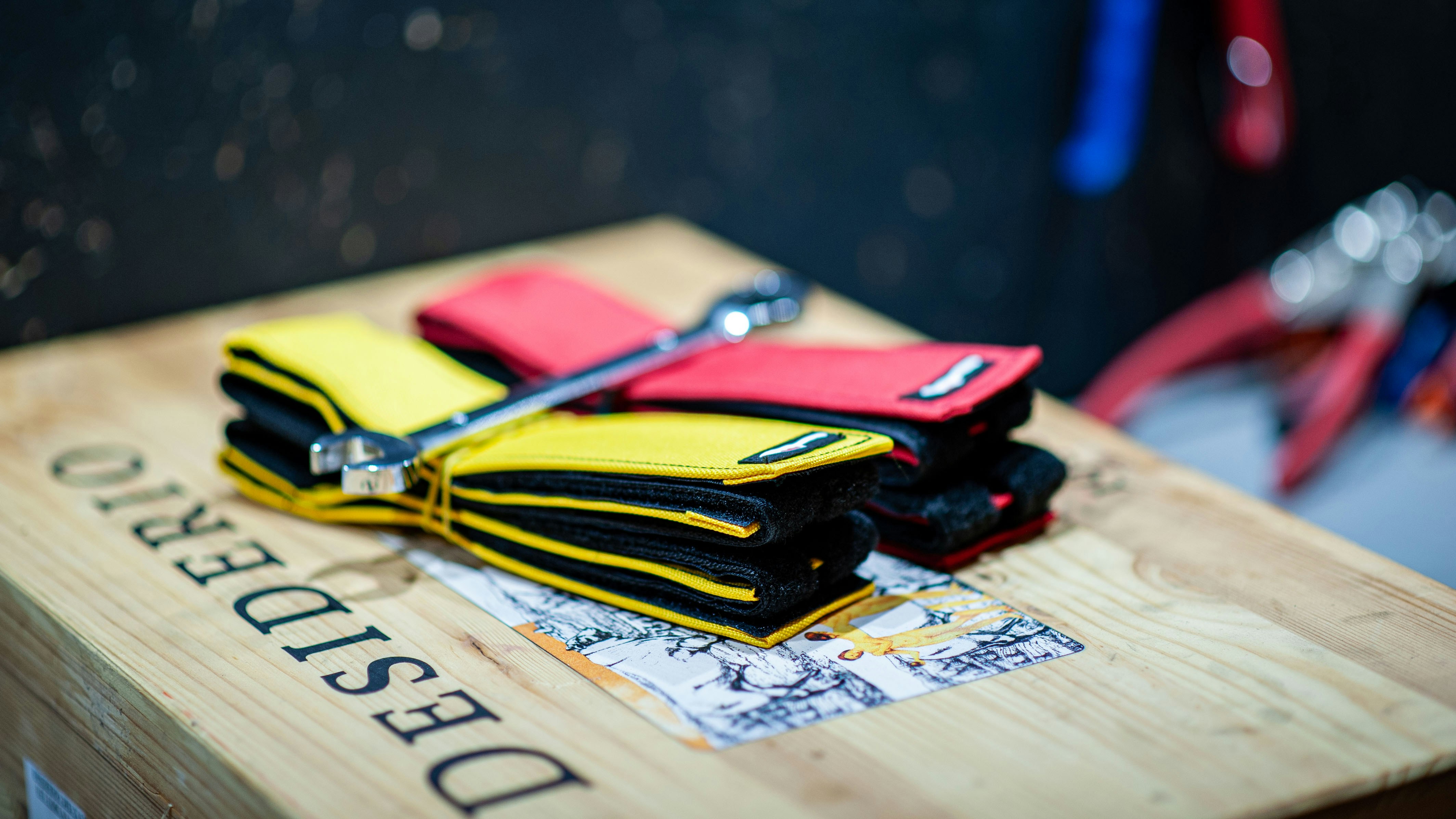 Colorful leather pouches resting on a wooden workbench