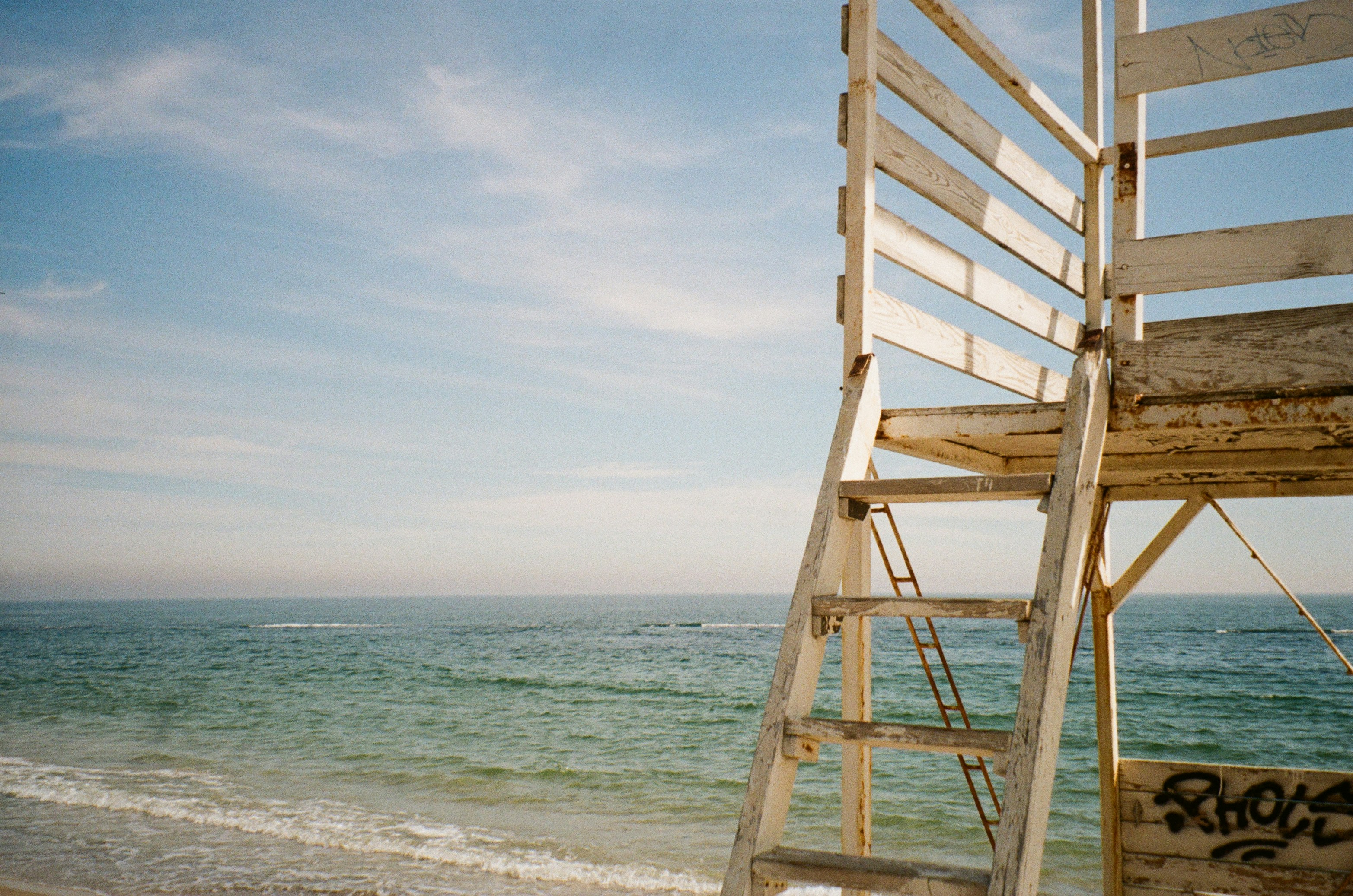 Foto Una estructura de madera en una playa – Imagen Paseo por el mar ...