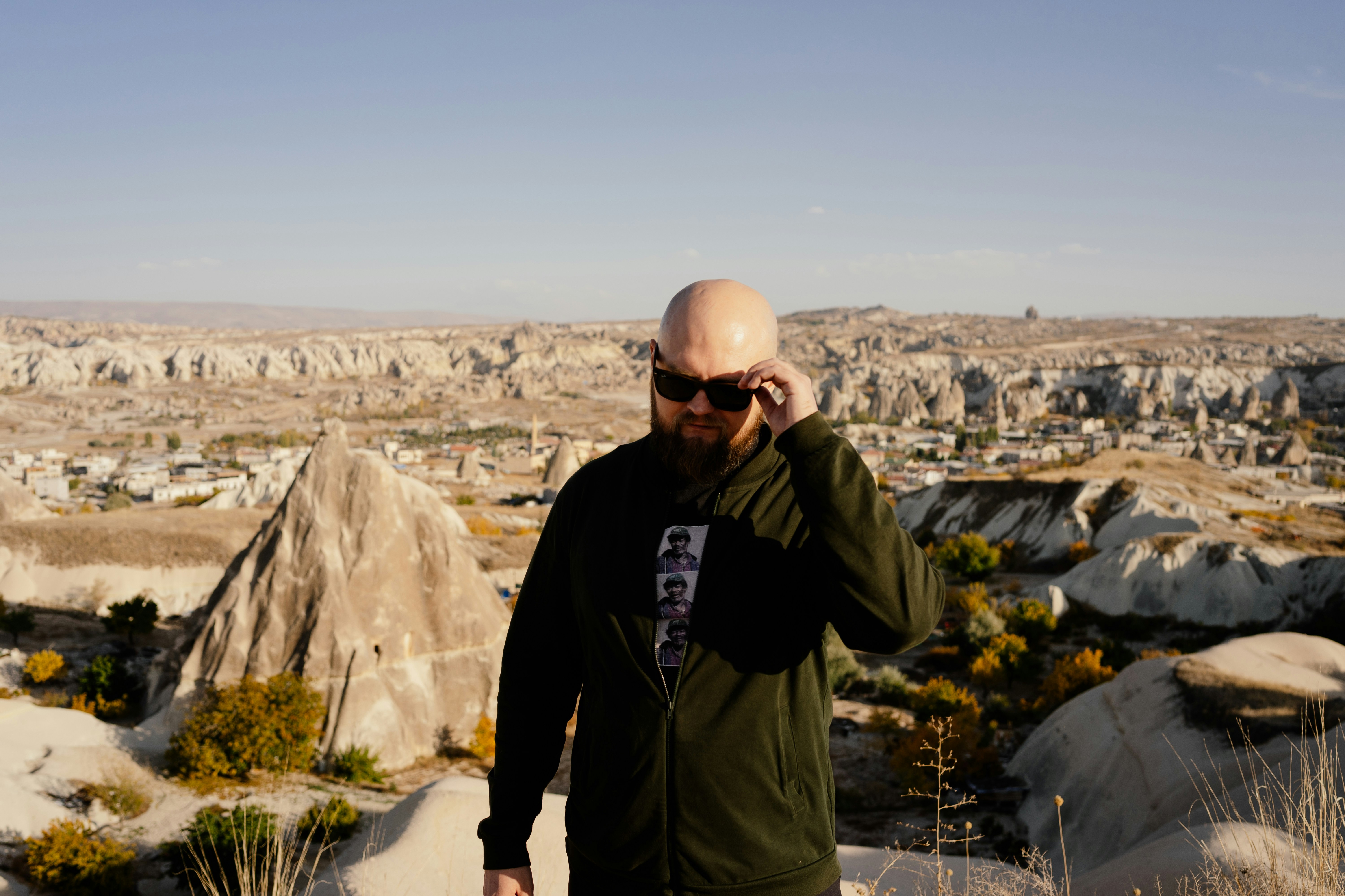 Desert Cliffs and the Solitary Wanderer: A Quiet Moment Under Pale Sky