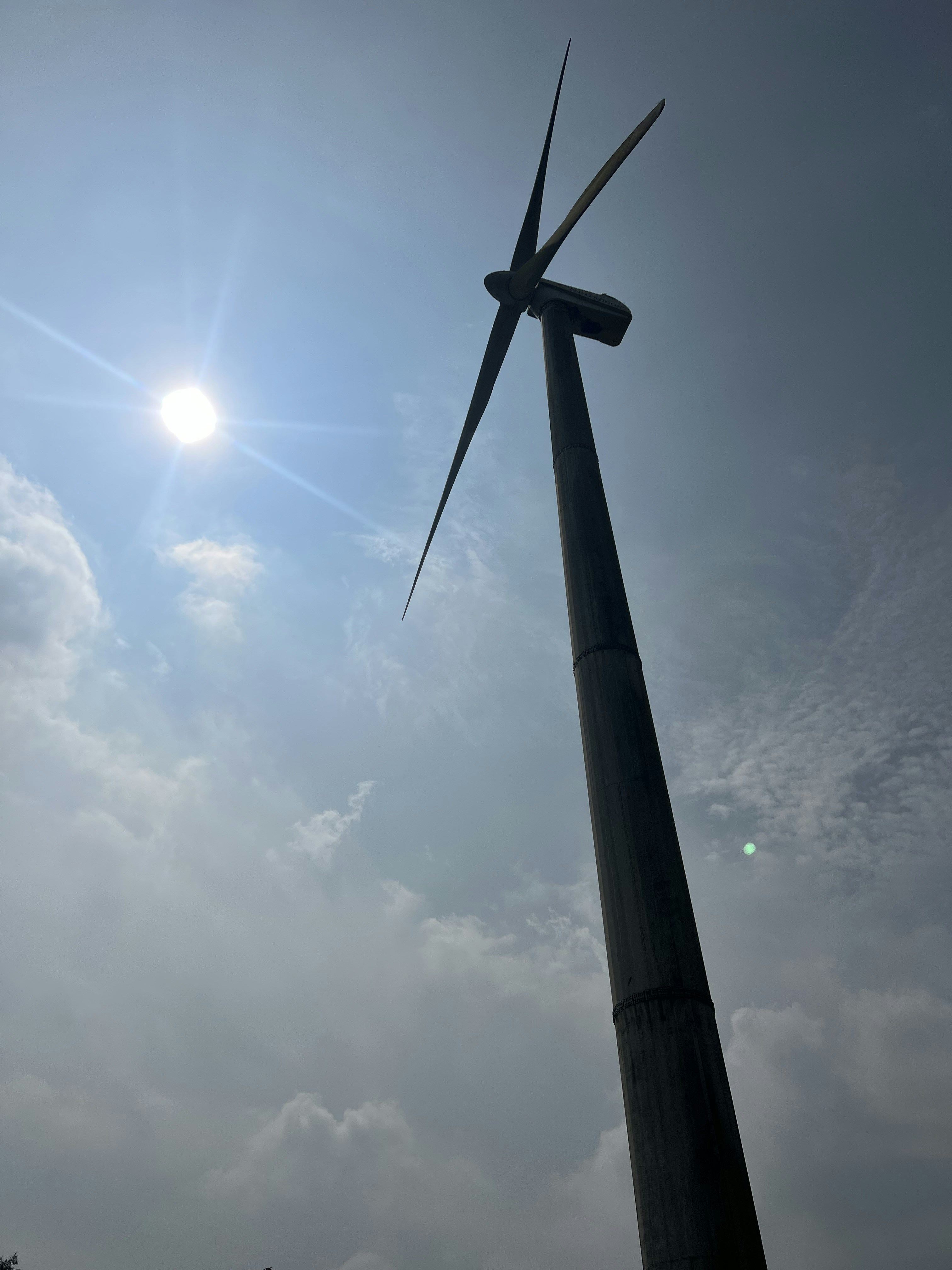 Towering Wind Turbine Reaching Toward a Bright Sky