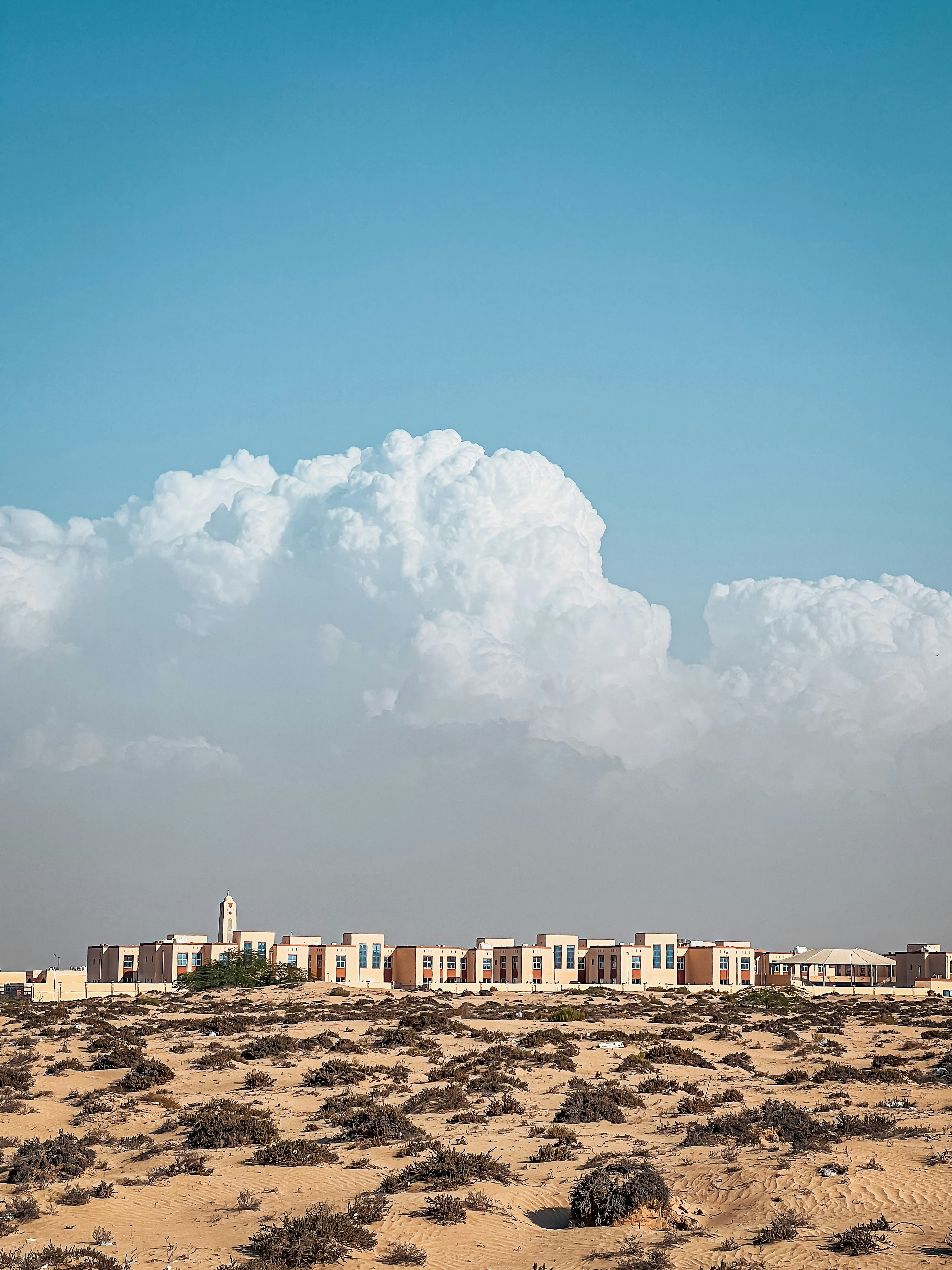 Desert Edge Village under a Cloud-sculpted Sky