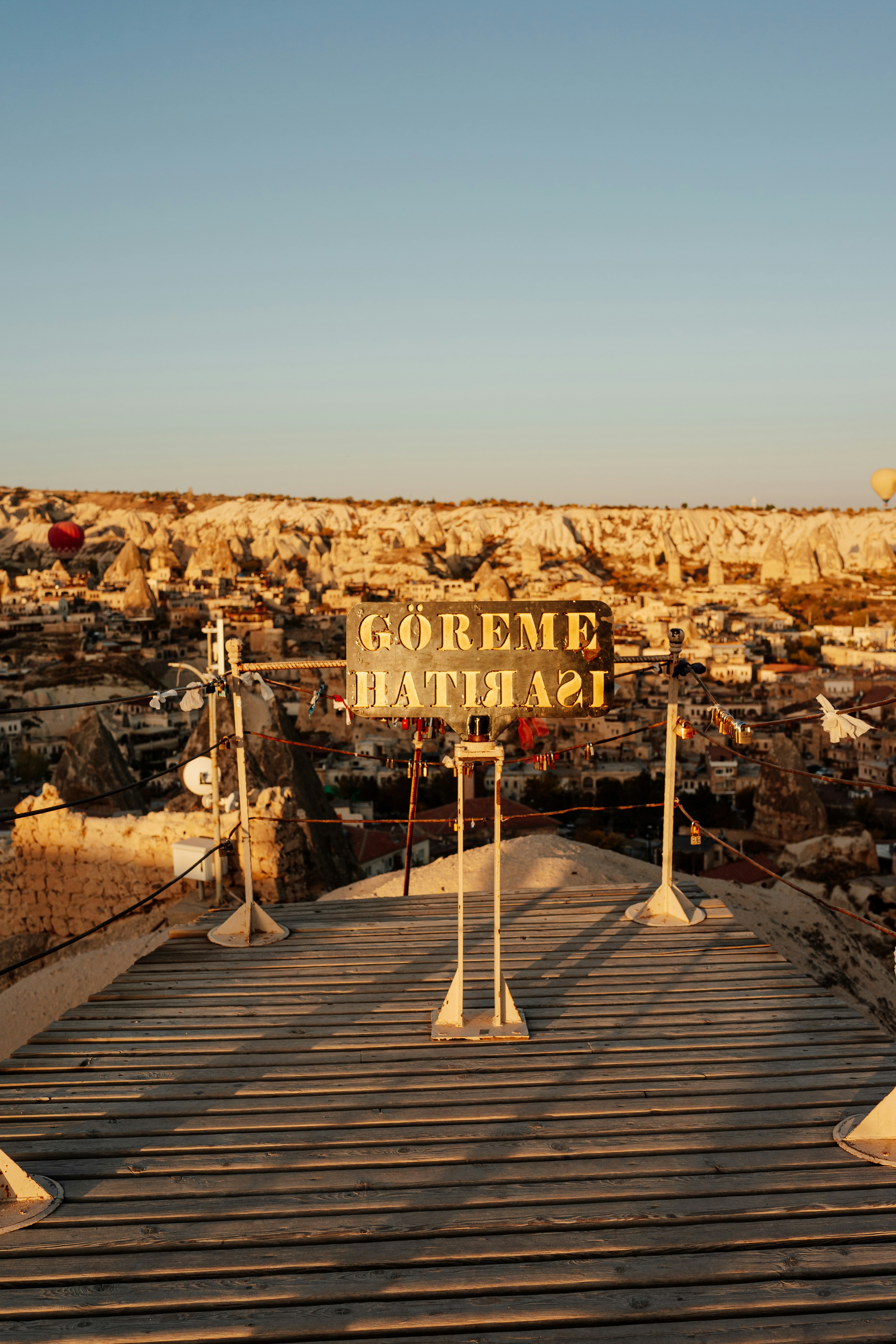 Goreme Rooftop Sign at Golden Hour Over Cappadocia's Painted Horizon