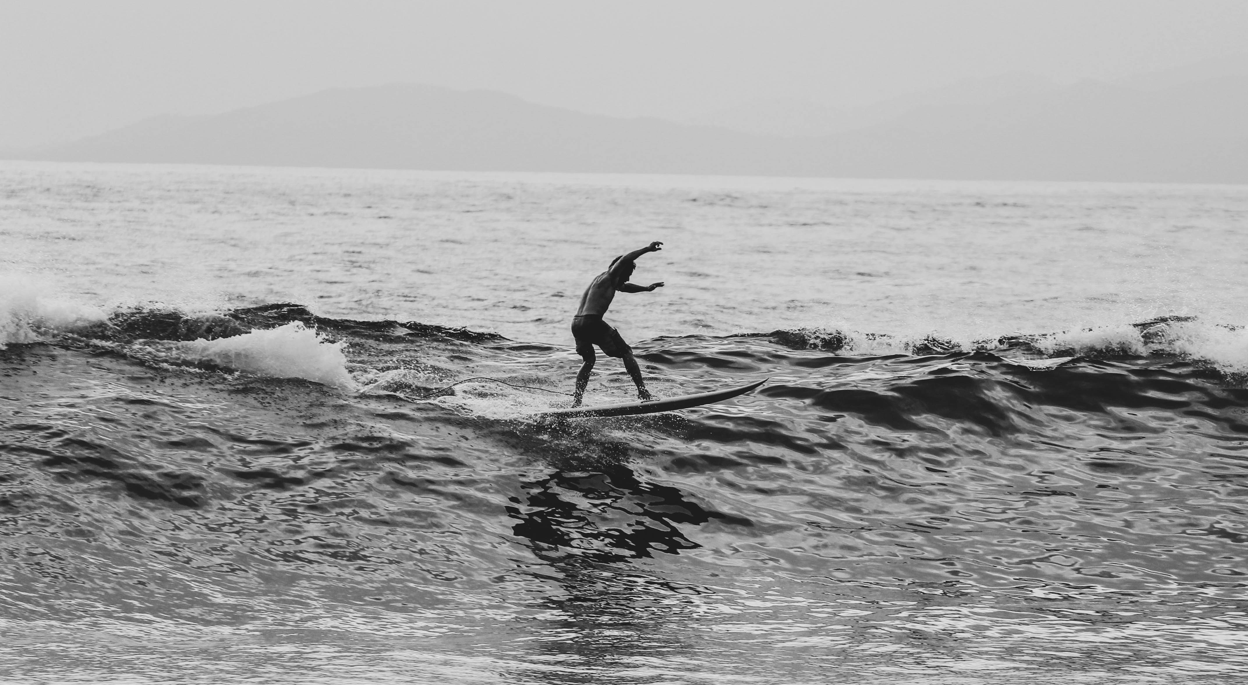 Silhouette Rider: A Lone Surfer Gracing the Dawn-Washed Sea