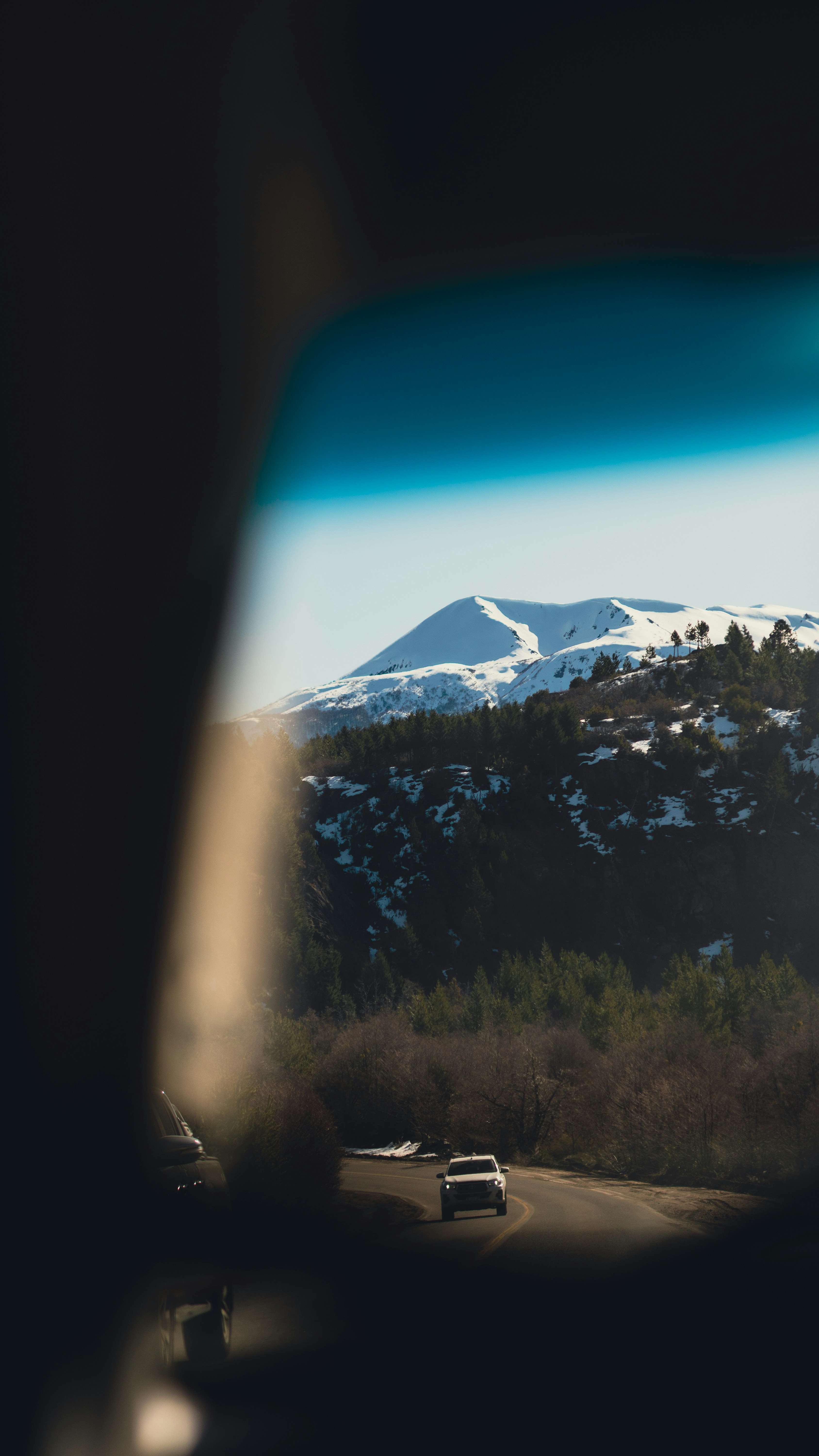 Snow-capped Peaks Framed by a Narrow Car Window
