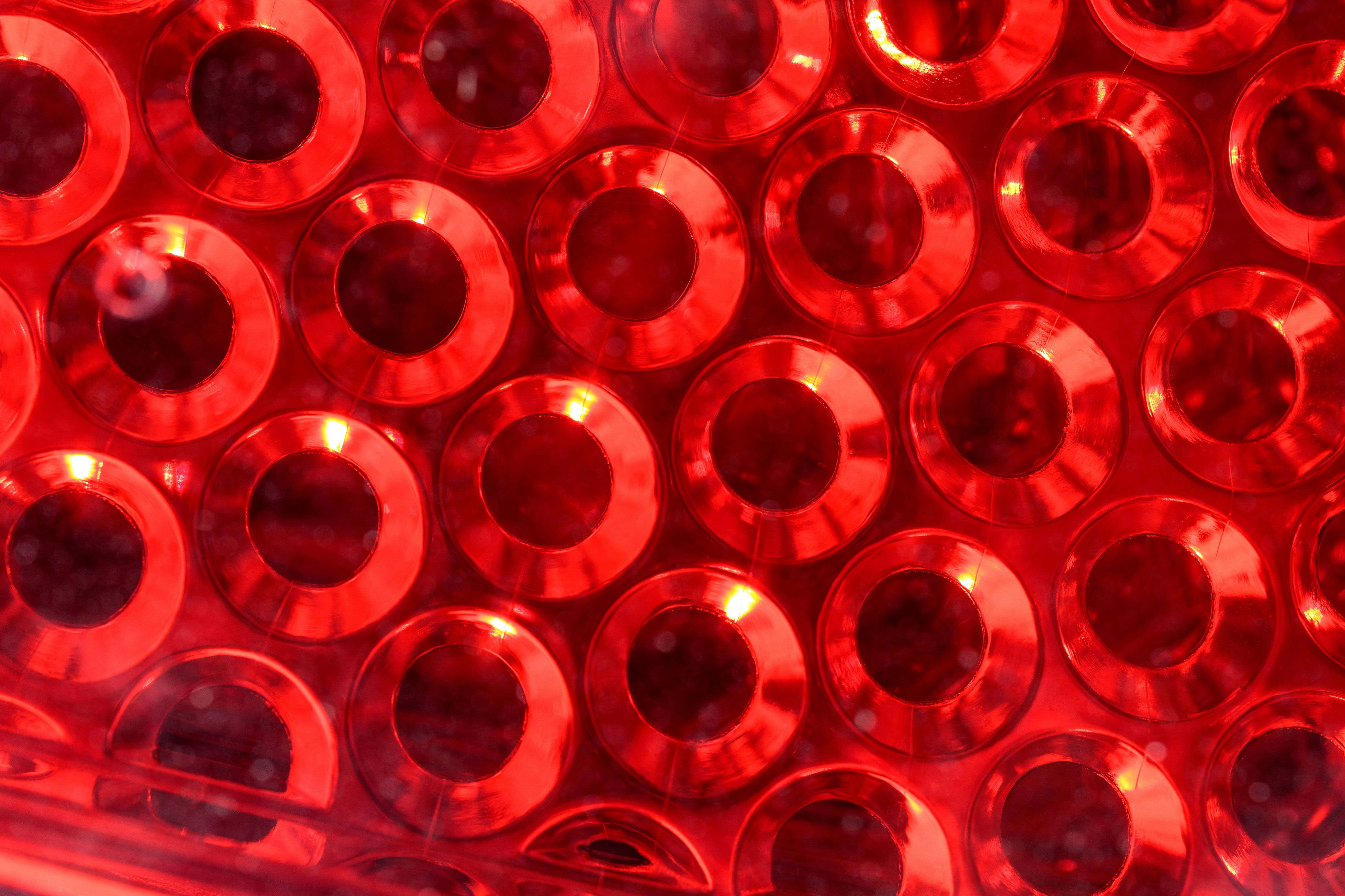 Red Orbs: A Close-Up of Rhythmic Circles in Glassy Light
