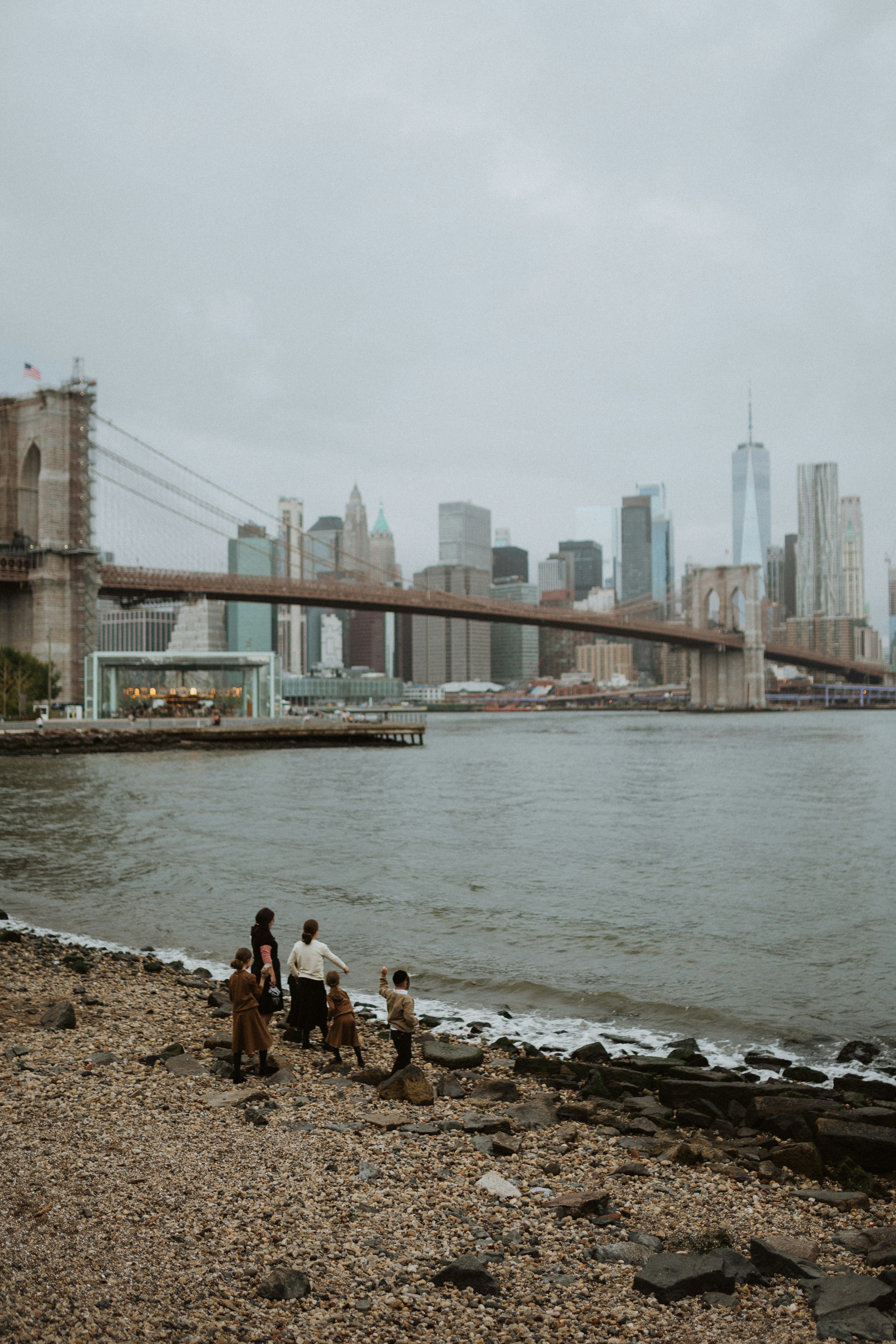 Family by the River Under the City’s Graceful Span