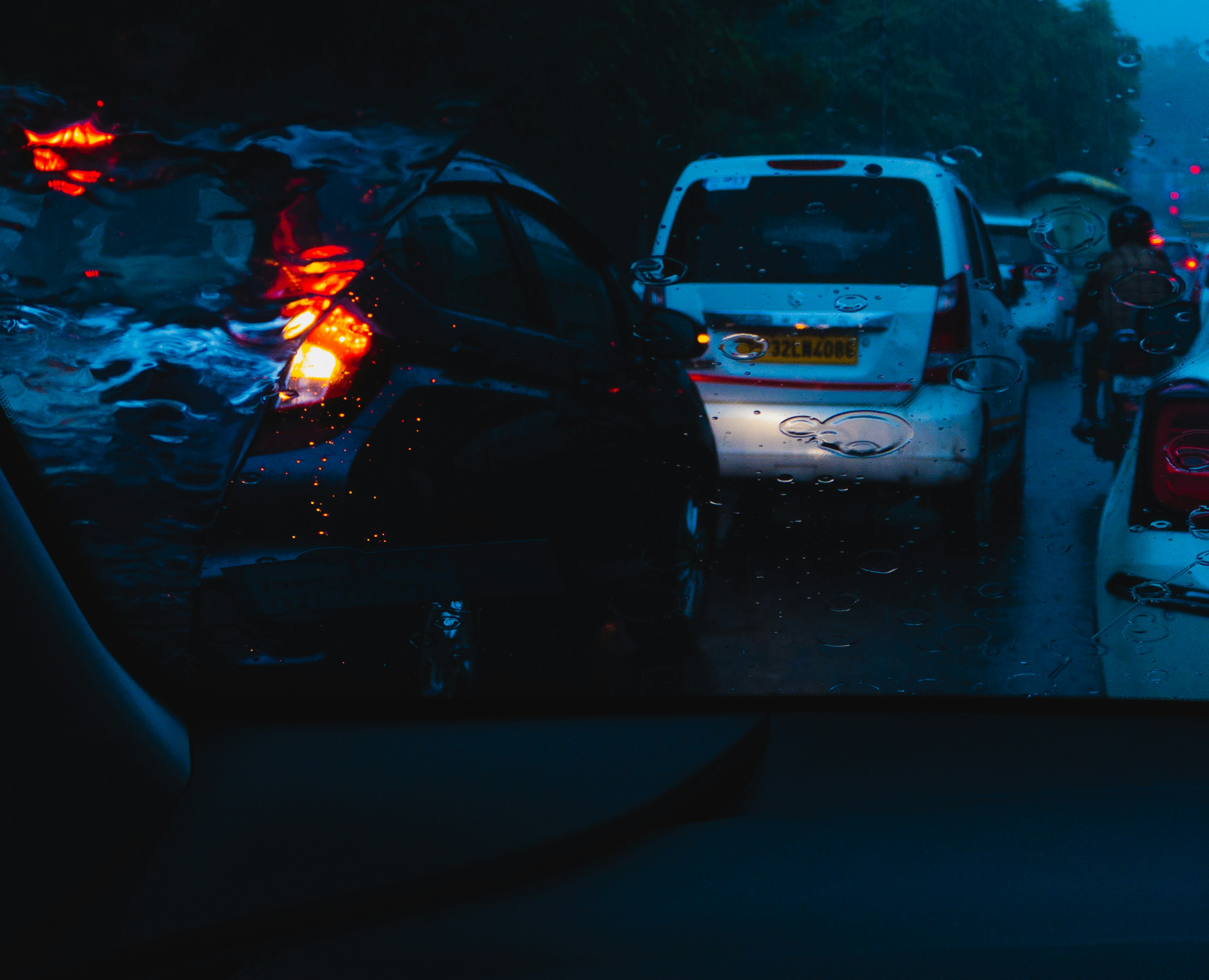 Tail-end Traffic Chaos: Neon Reflections in a Rainy Street