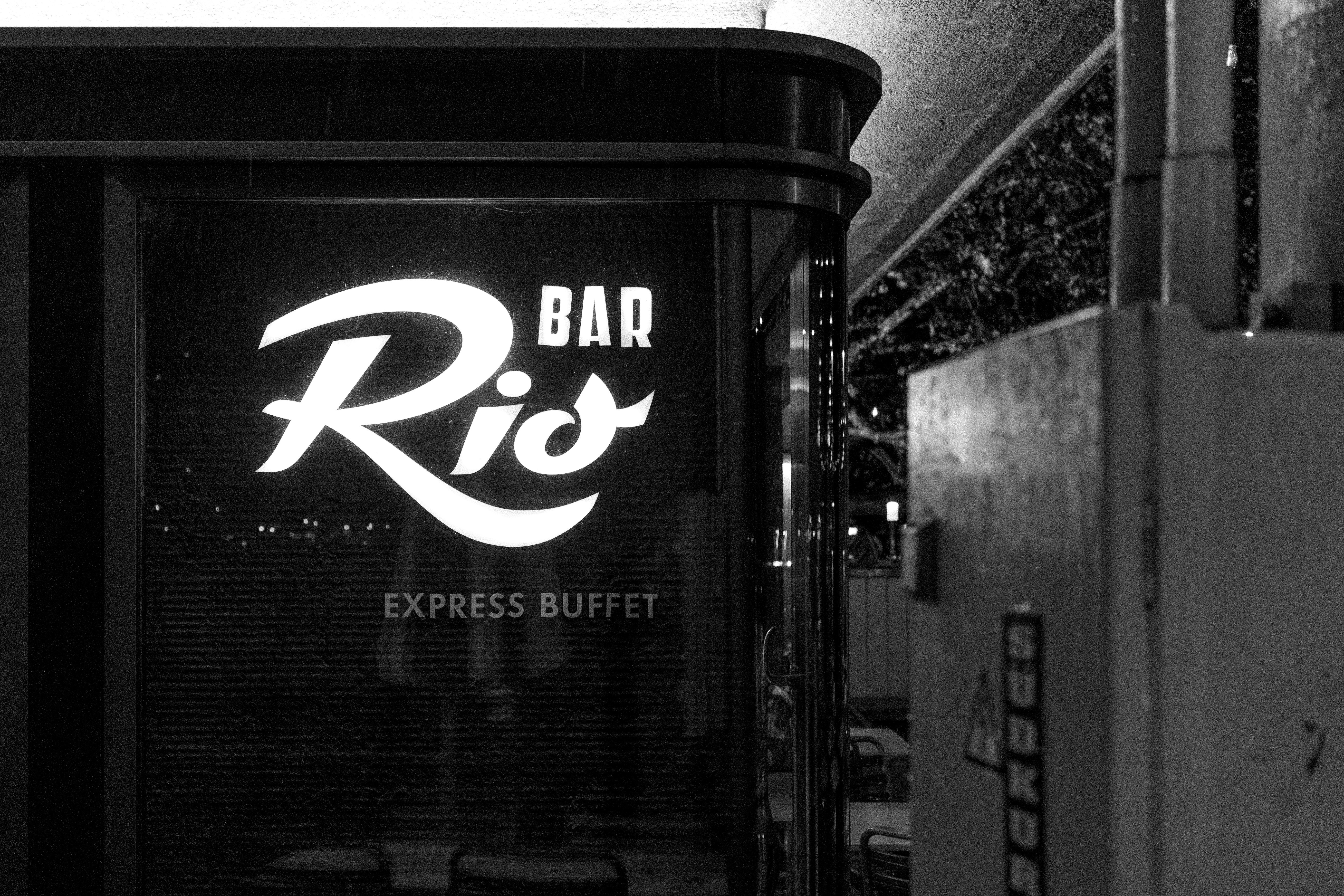 Neon-lit R&B: A Corner Sign in Quiet Monochrome