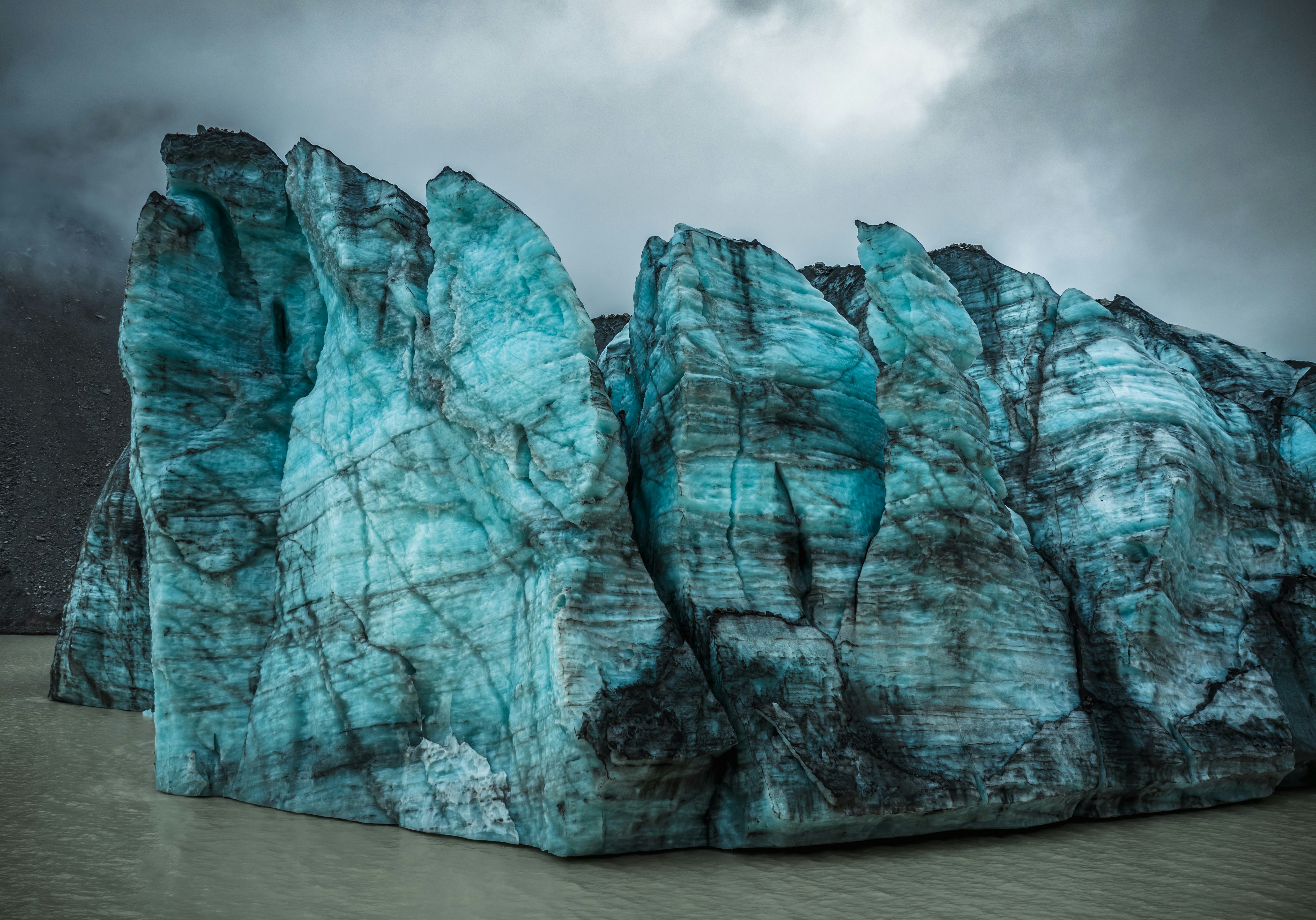 Blue Ice Monoliths Under a Tempest-Cloud Sky