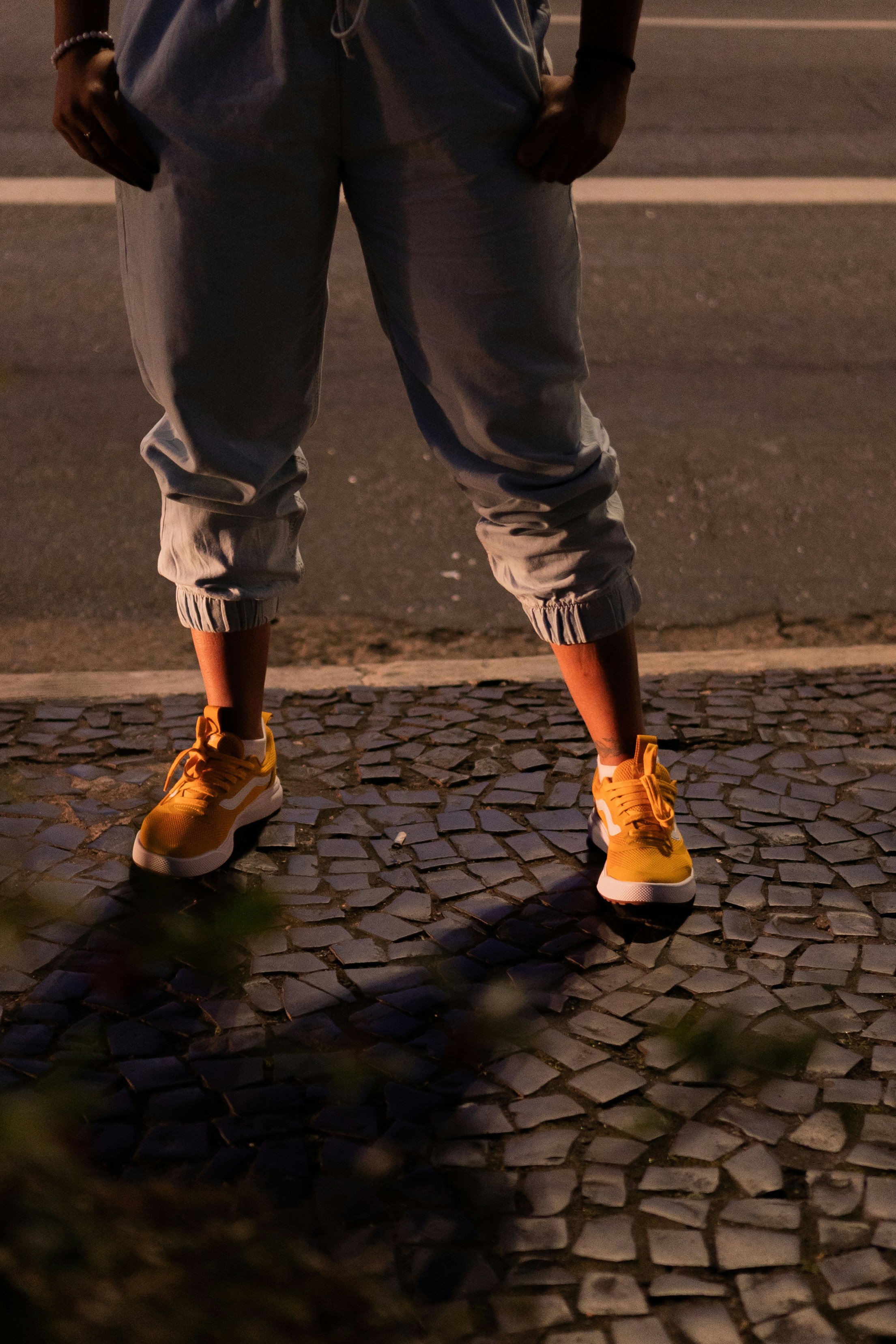 Golden Kicks on Cobblestone Night: A Street-Style Stance