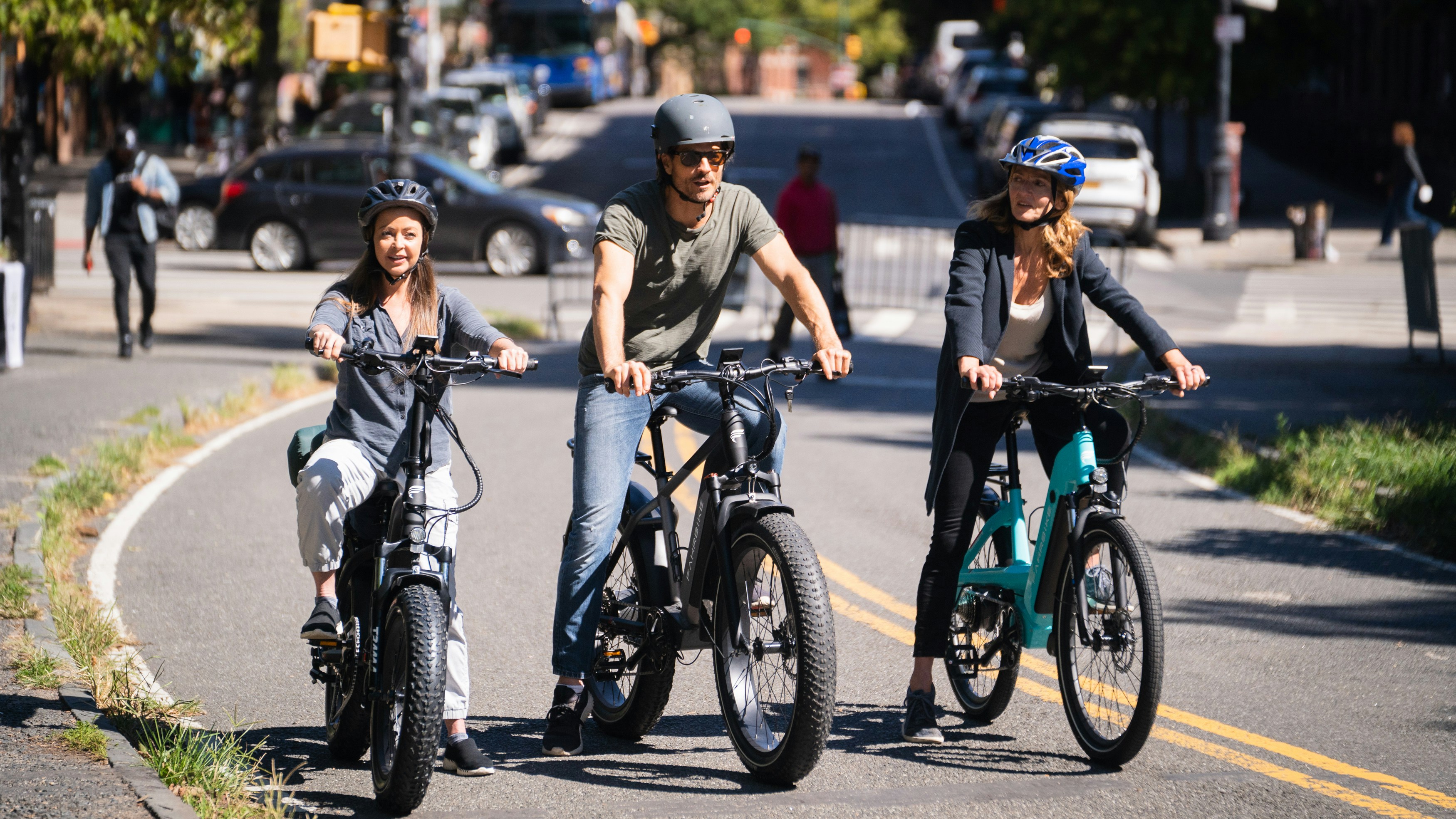 A group of people riding bikes on a street photo – Free Ebike Image on ...