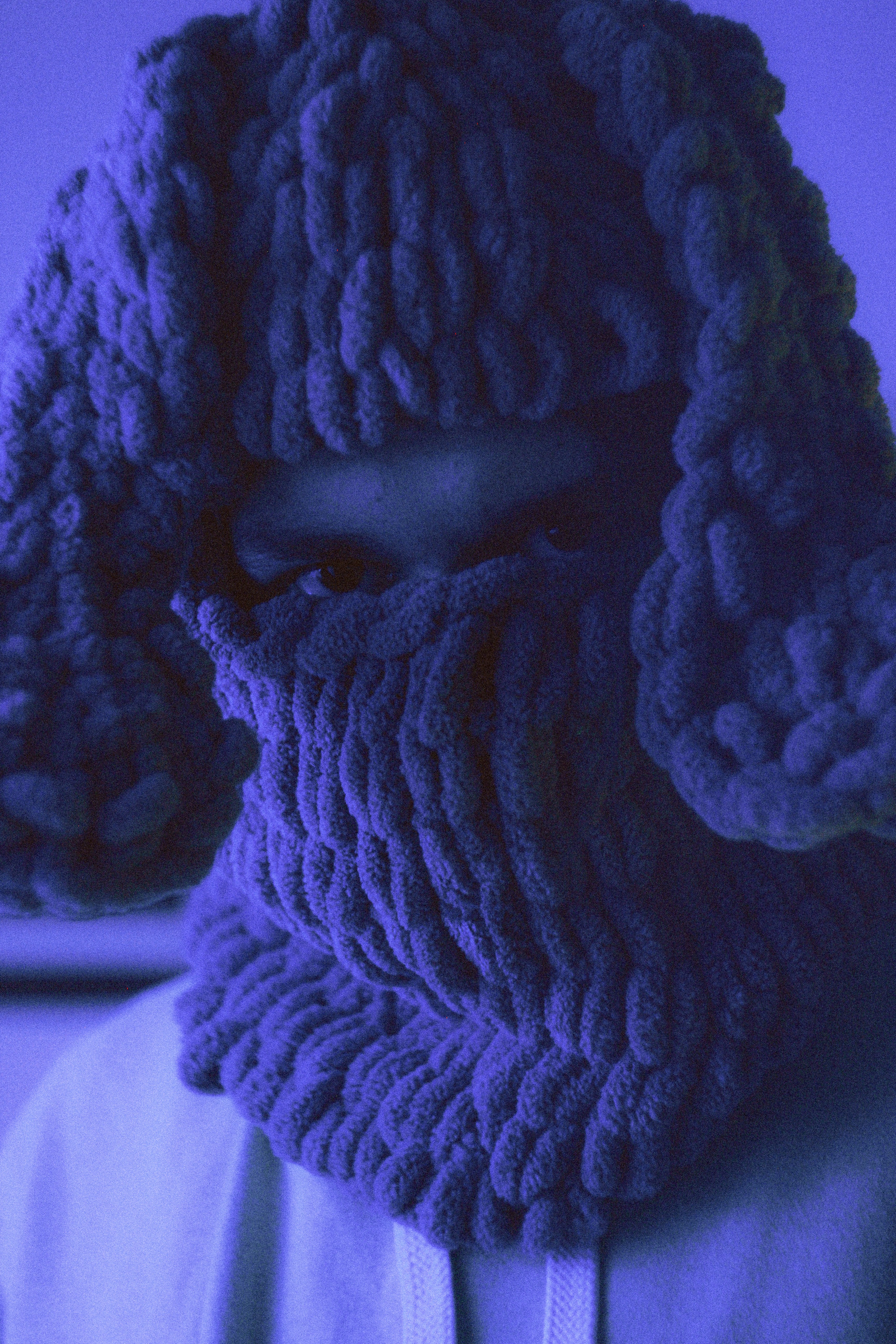 Veiled Gaze: A Clothed Silhouette in Indigo Knit