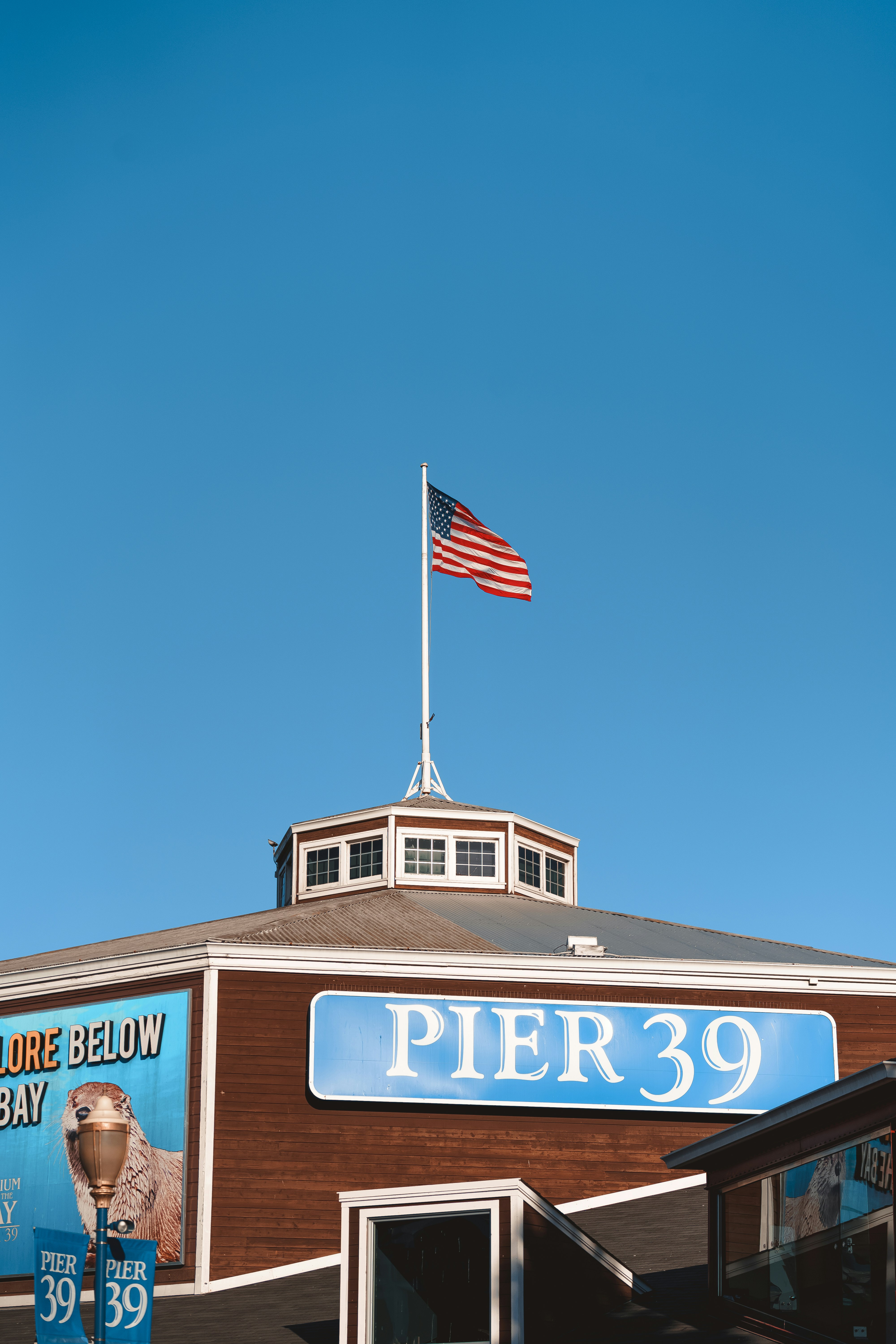 Flag atop Pier 39: Blue Sky Over a Seaside Icon