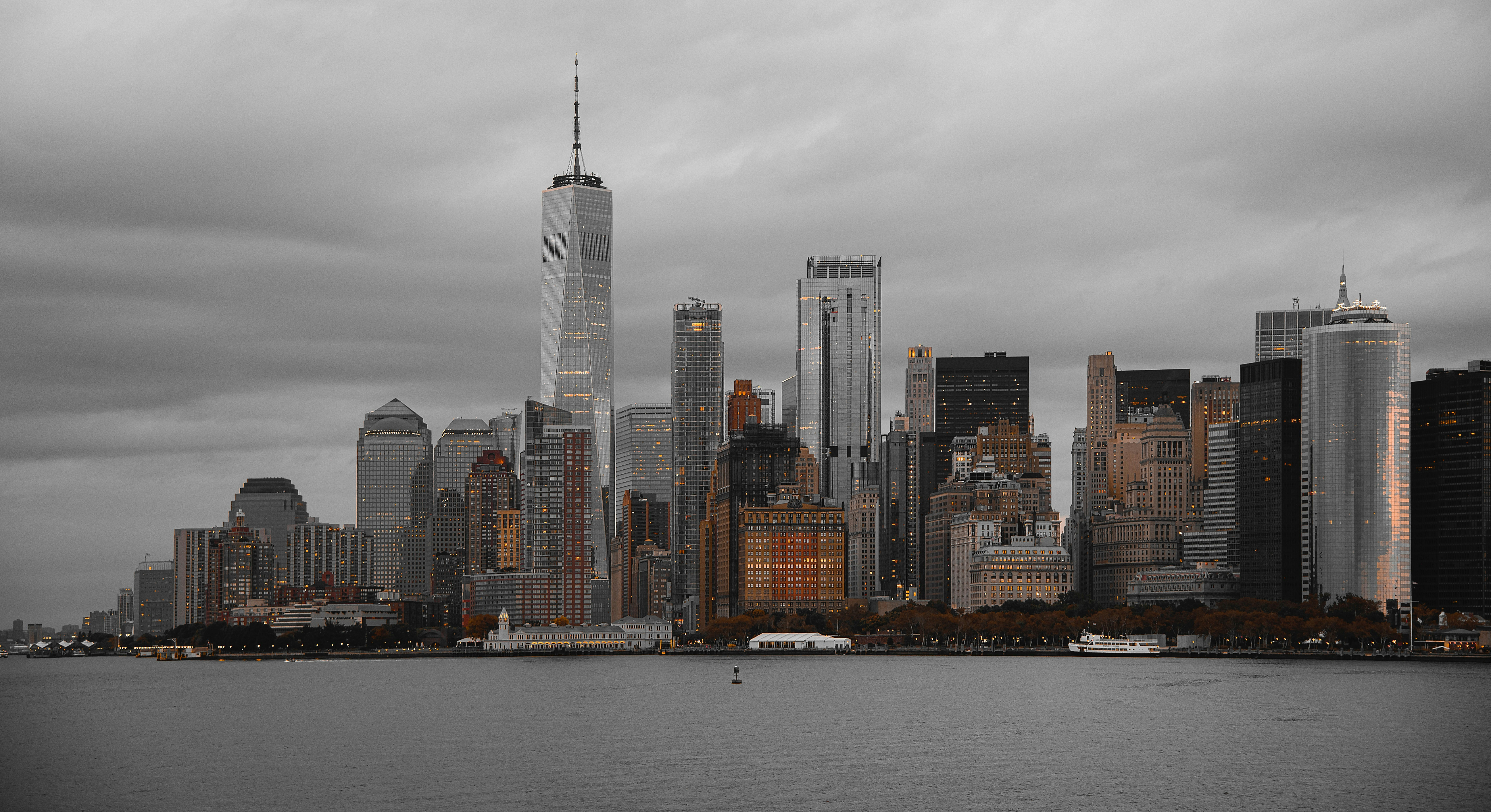 A city skyline with a body of water in the foreground photo – Free ...