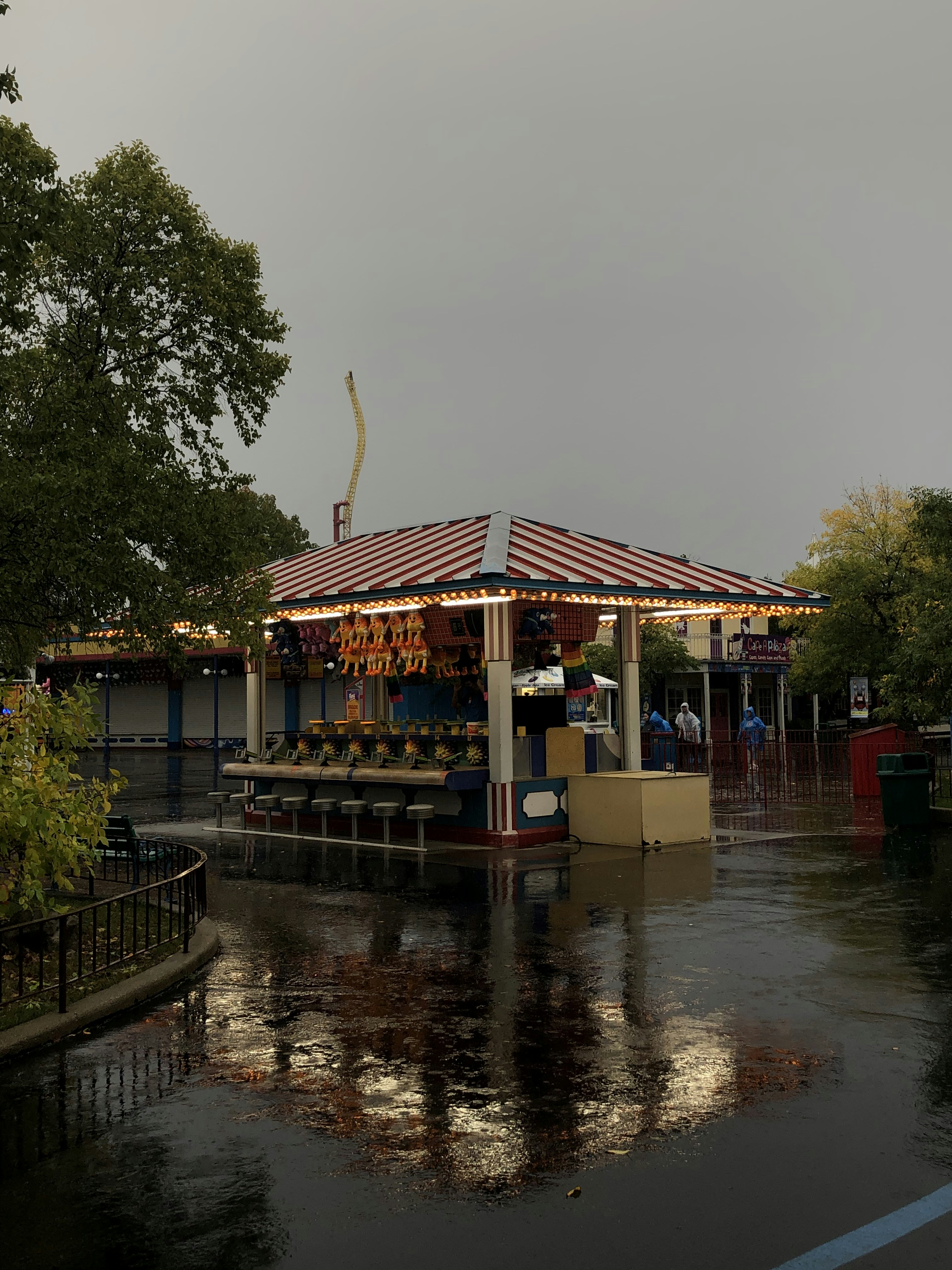 a building with a red roof and a red roof surrounded by water
