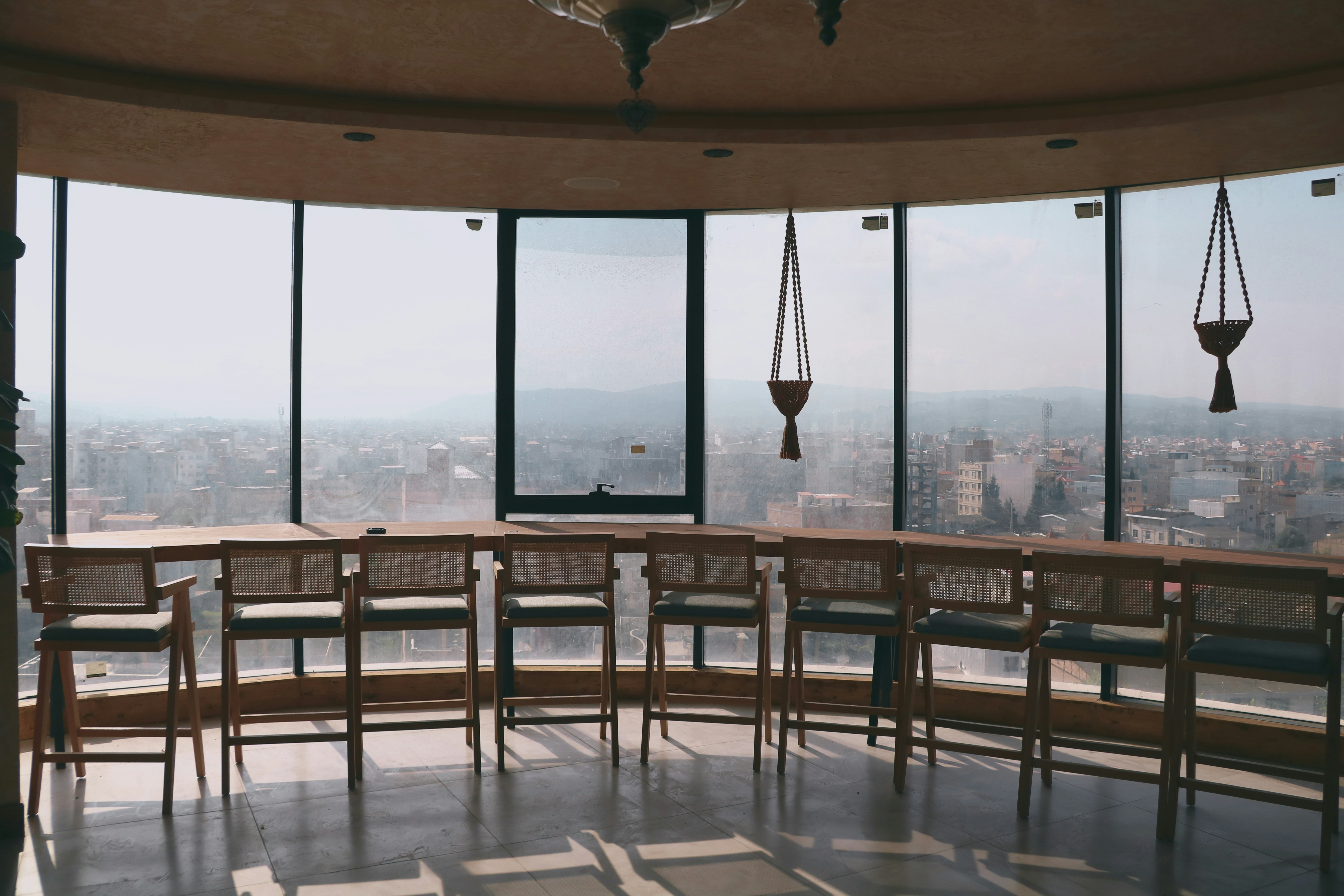 Windowed Skyline Lounge: Rows of Chairs Framing a City Horizon